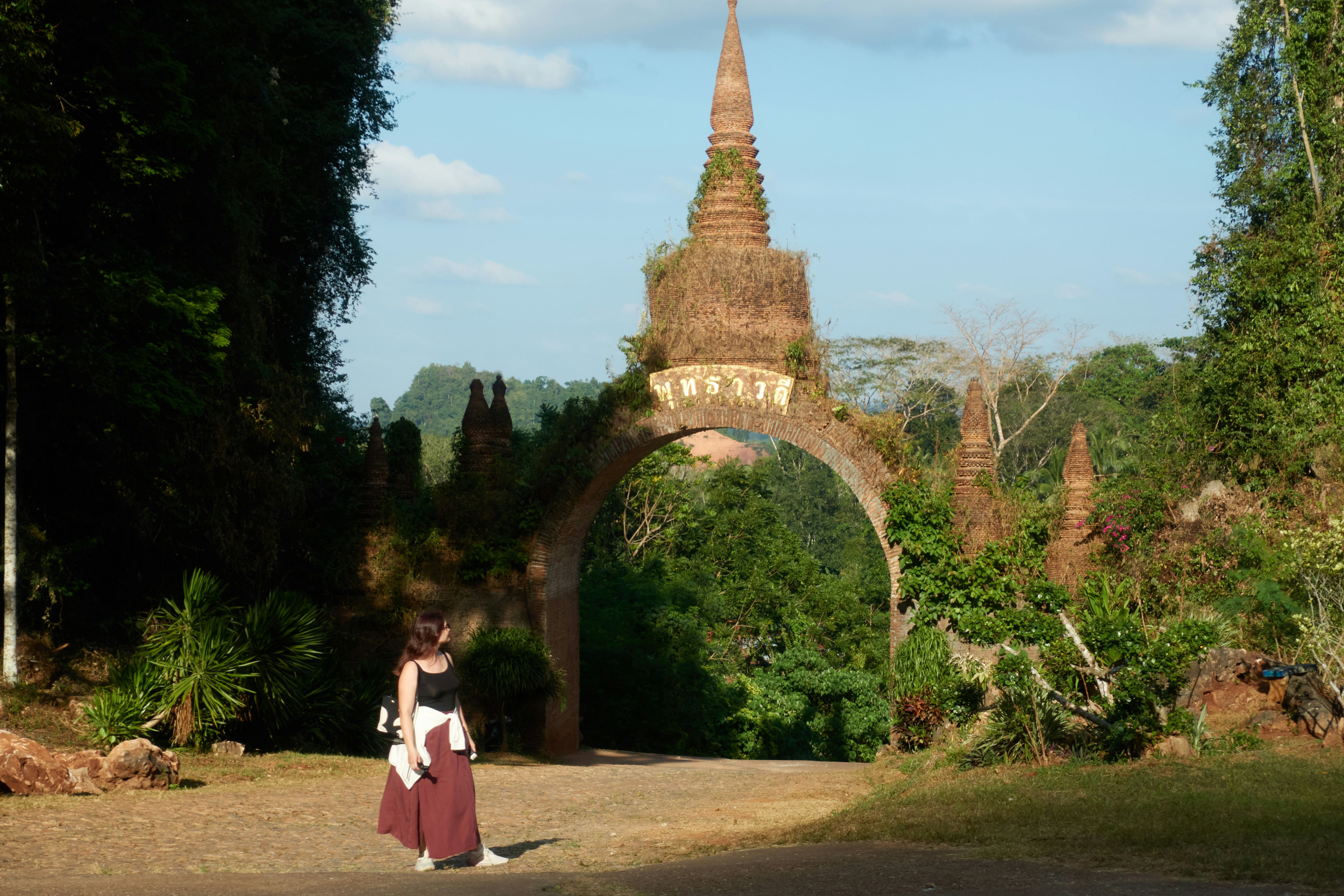 Pastel Archway and Lone Visitor in an Ancient Ruin Garden
