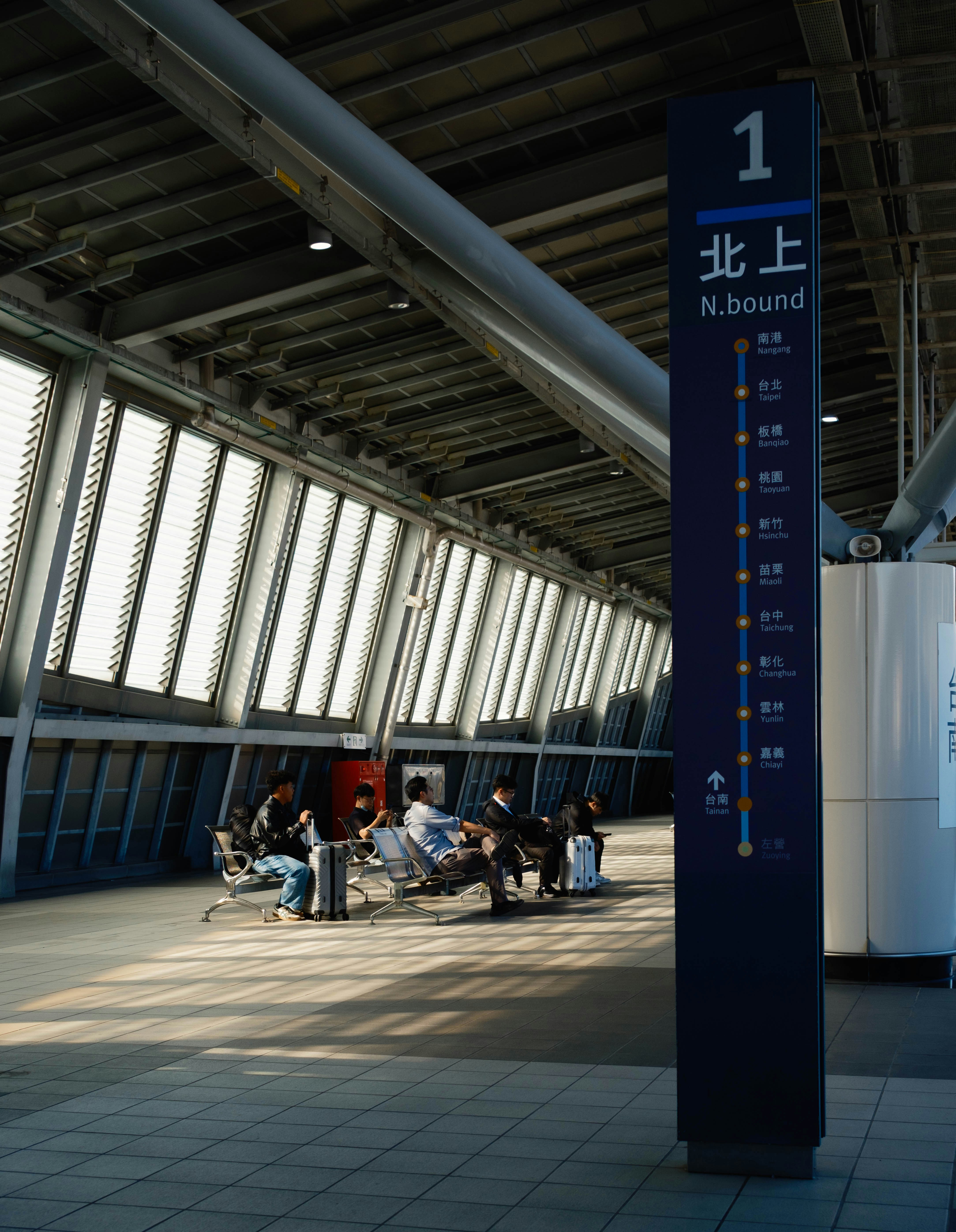 Quiet Pause at N.bound: A Sunlit Platform Scene