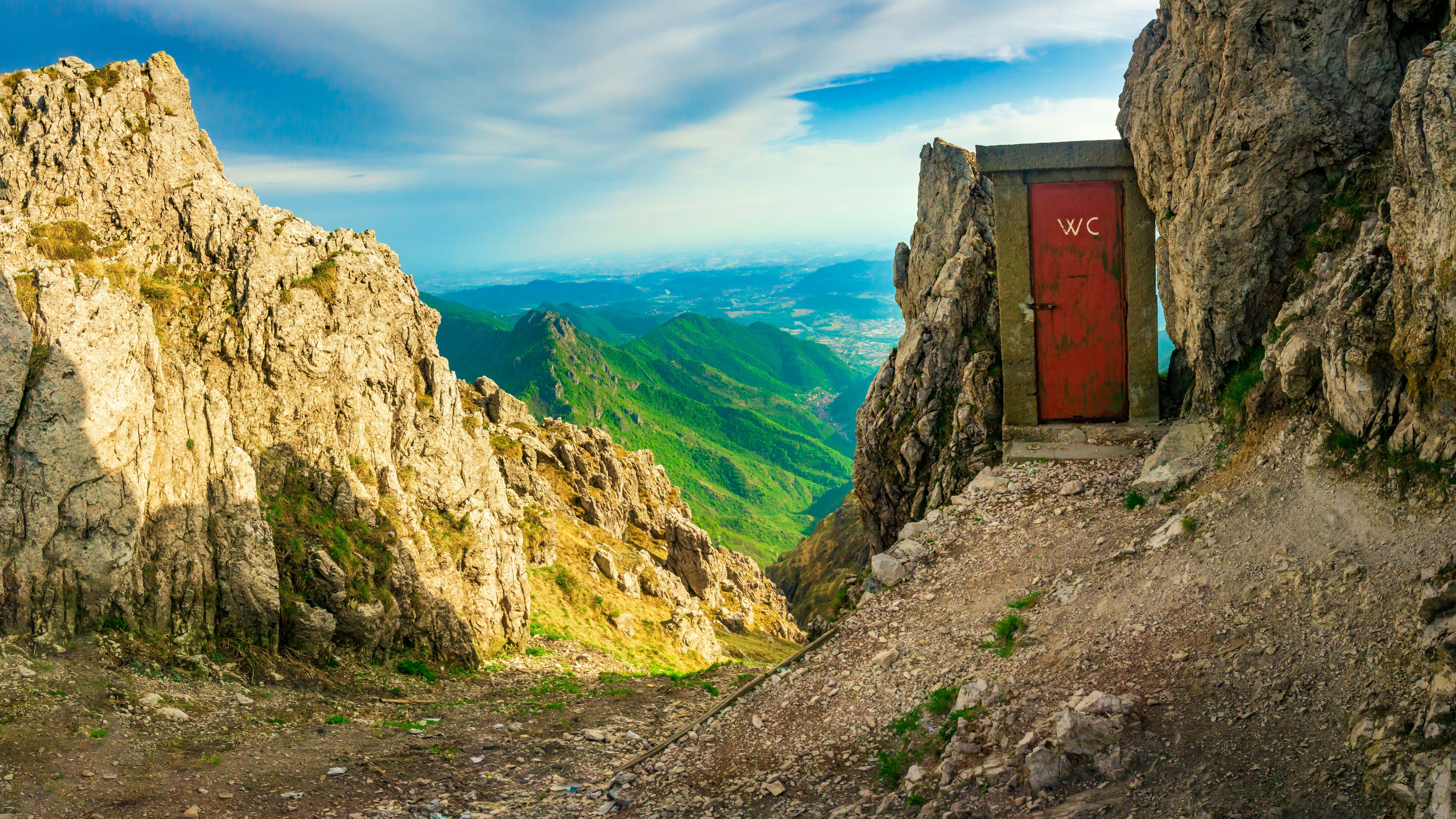 Trail to the Red Door: A Cliffside Restroom Above the Valleys
