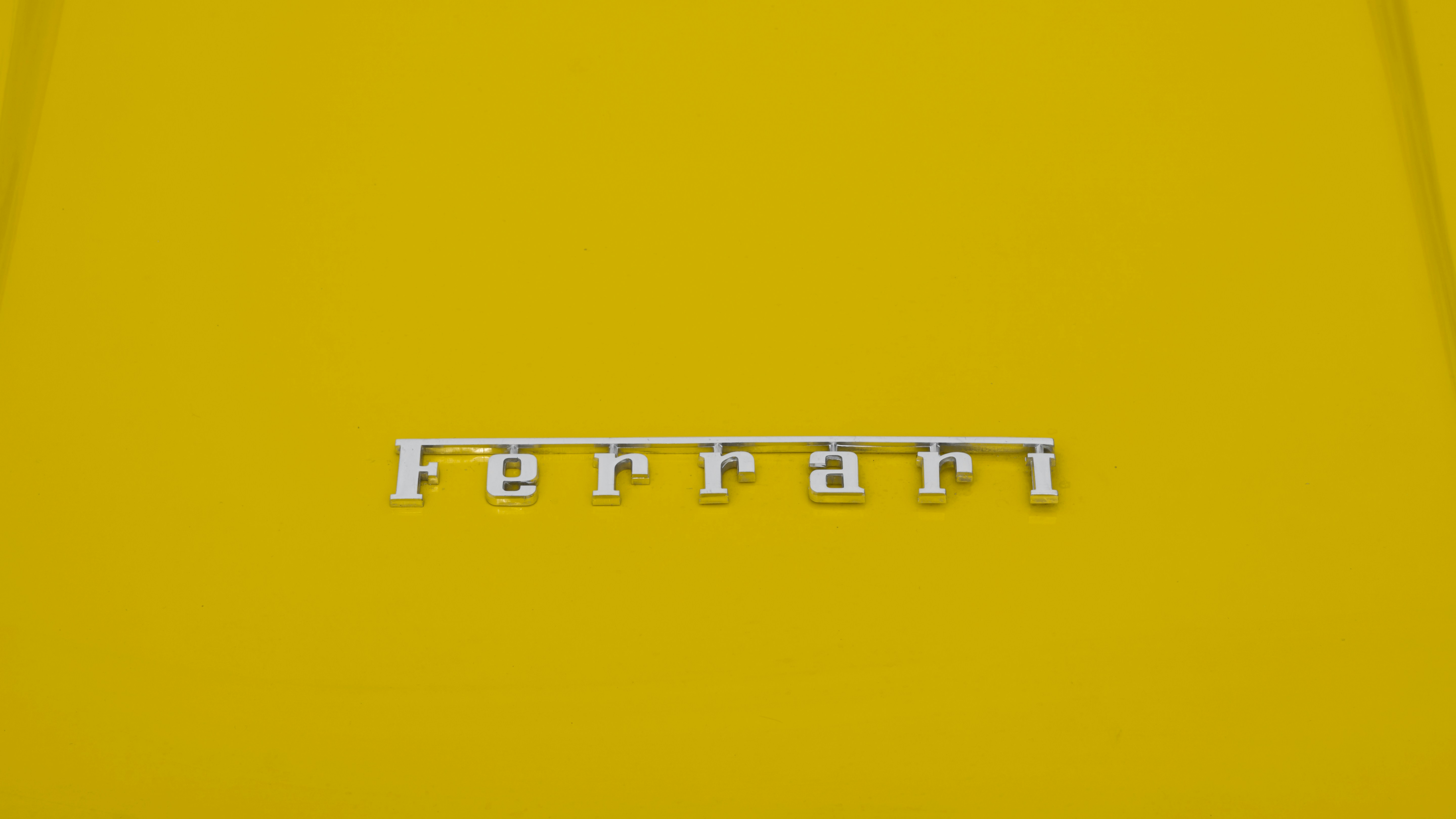 Ferrari Yellow: Emblem on a Bold Monolithic Surface