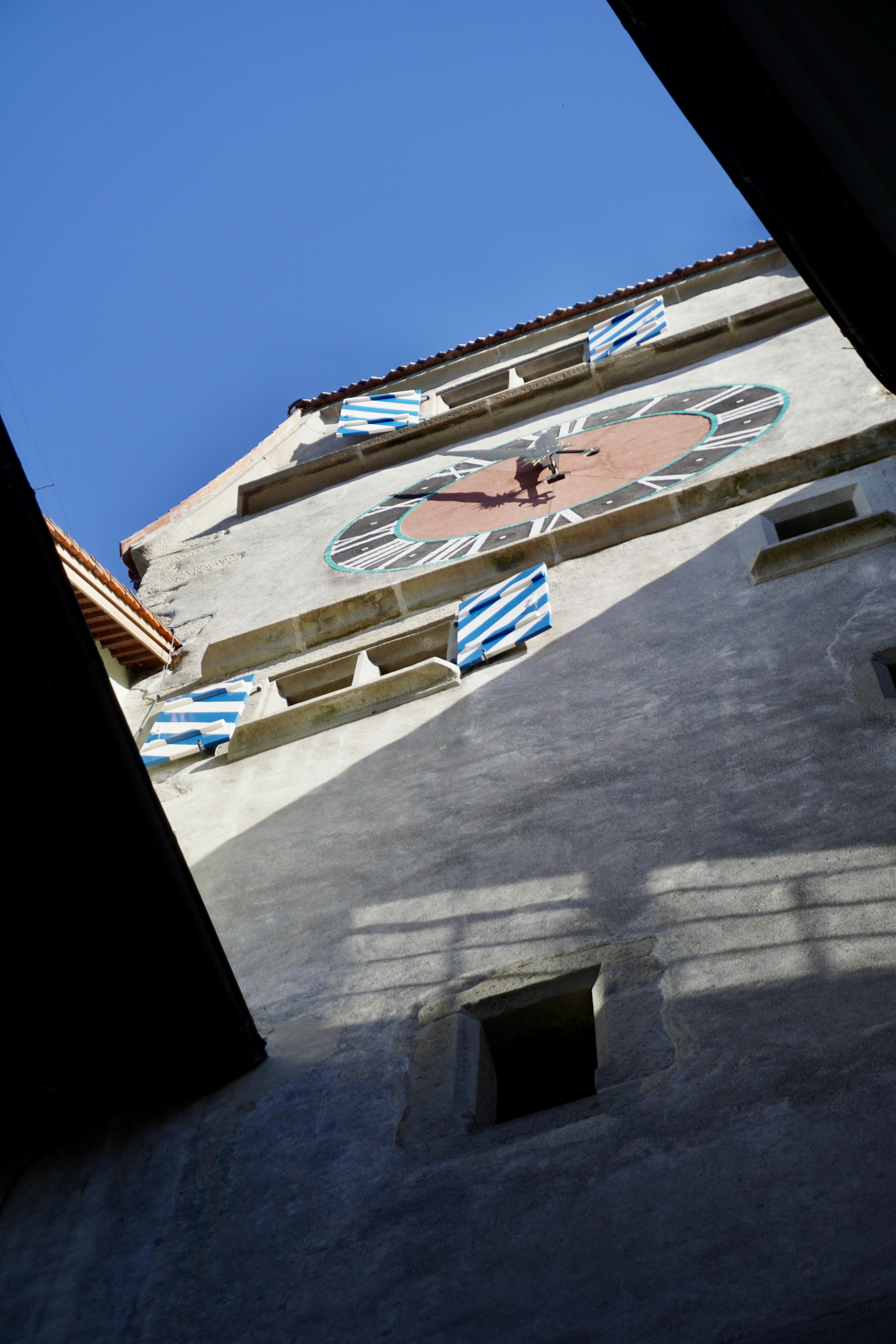 Toward the Clock Face: A Narrow Courtyard Ascends to Time
