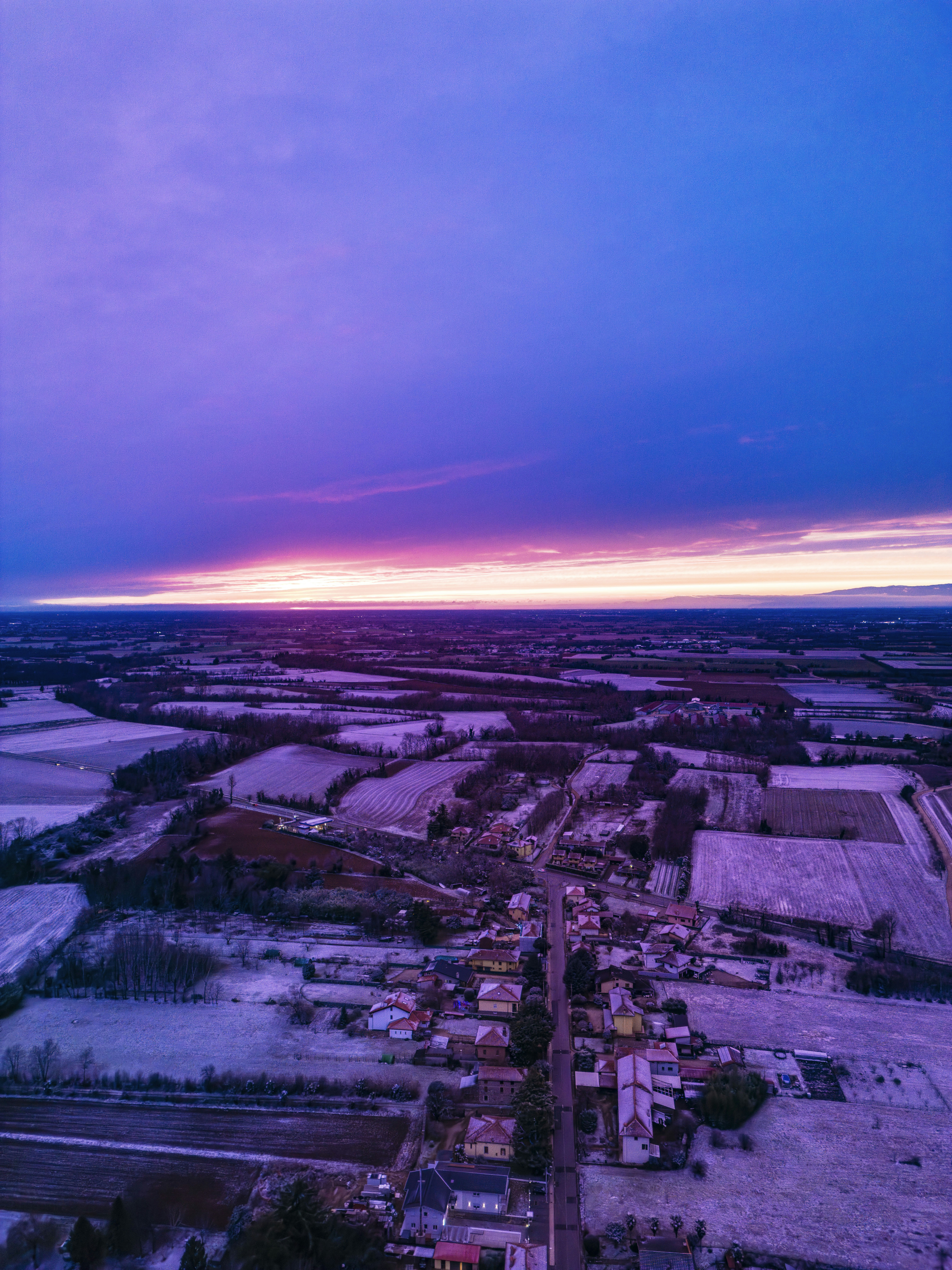 Horizon Fire: A Snow-kissed Valley Beneath a Lavender Twilight