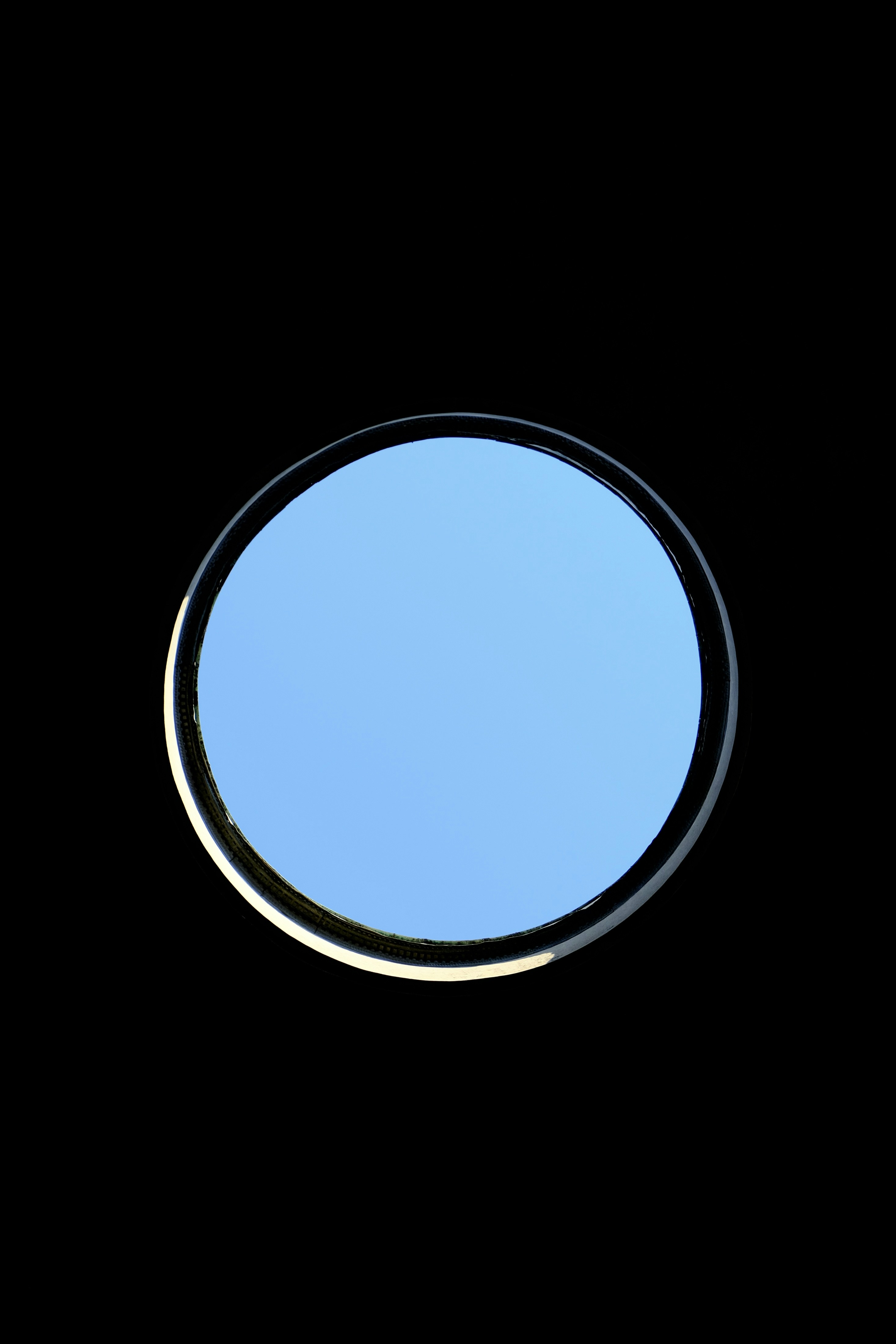 Blue Circular Window: Sky Through a Black Ring