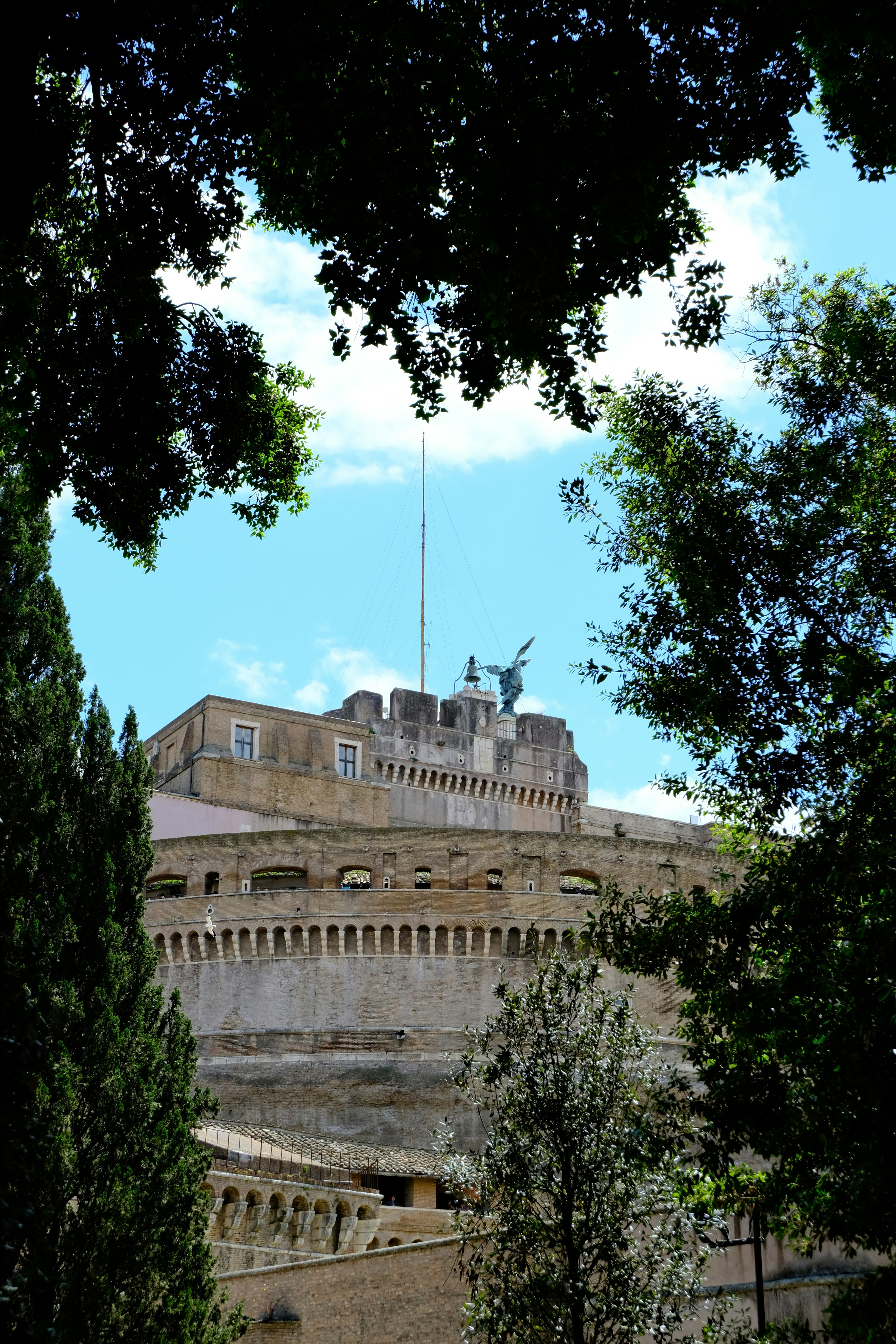Rome's Rock: A Fortress Framed by Silent Branches