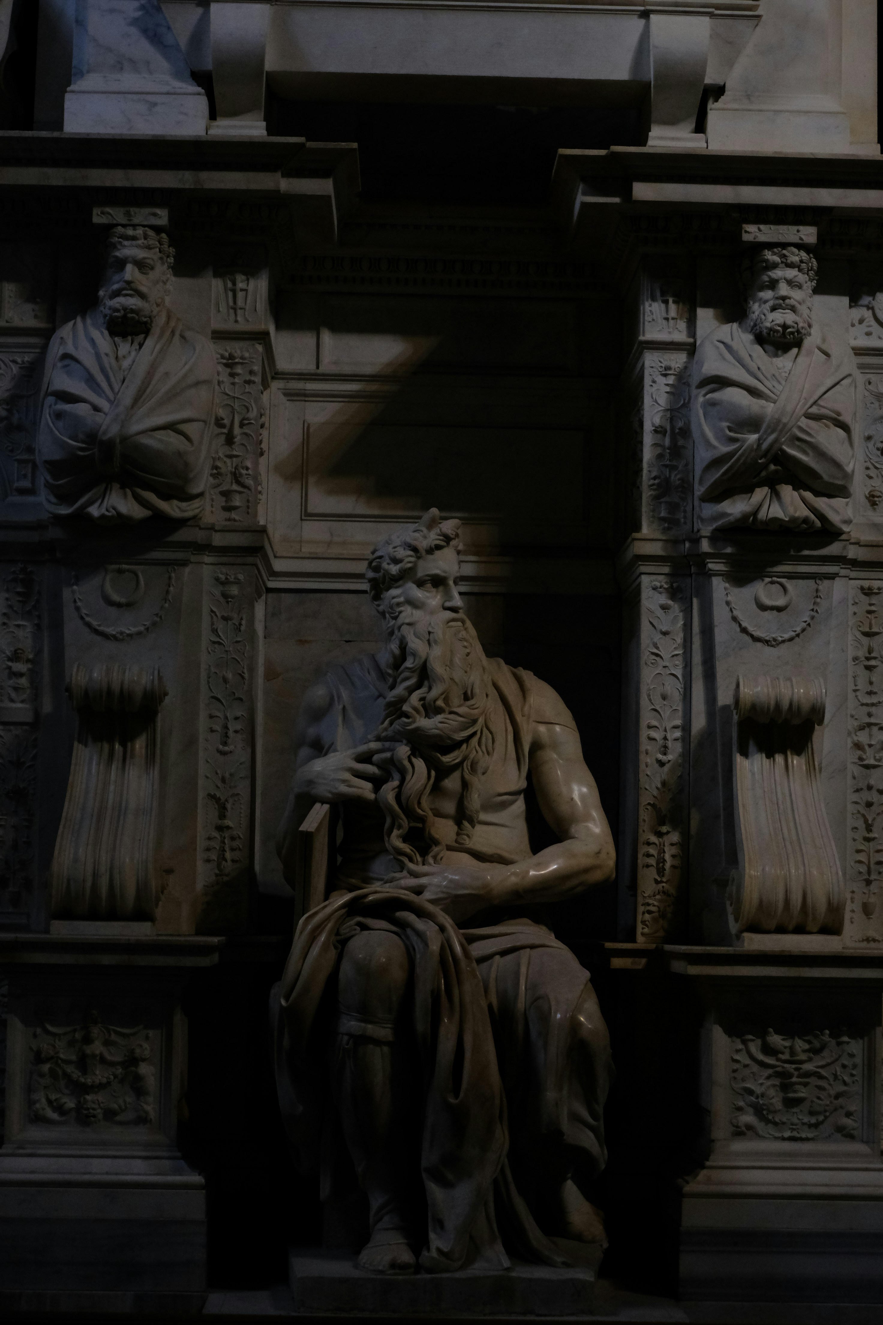 Shadows and Reverence: A Stern Seated Philosopher in Carved Facade