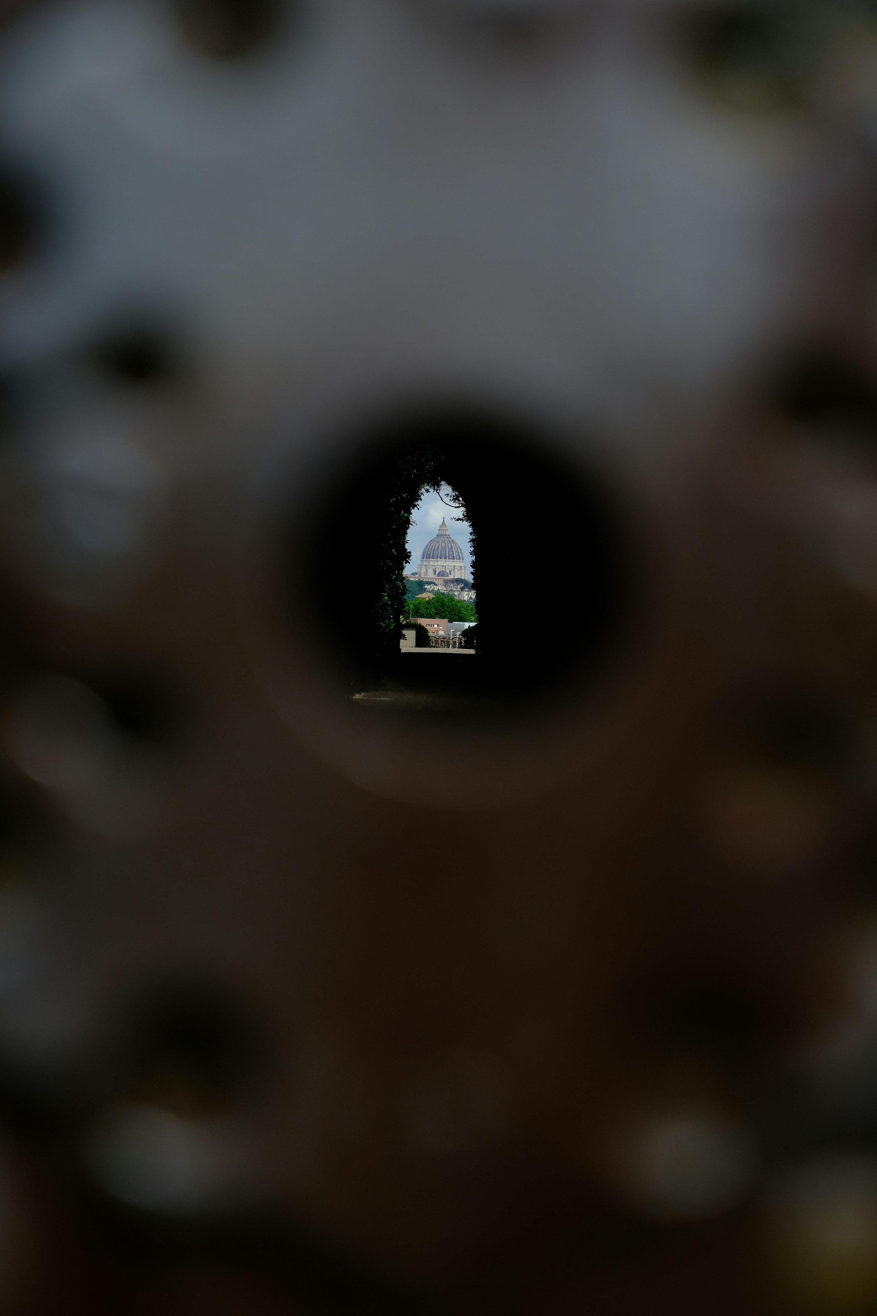 Through the Keyhole: A Distant Cathedral Framed by Macro Aperture