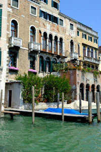 Venetian Facade Overlook: Bright Canalfront Arches and Mooring Posts