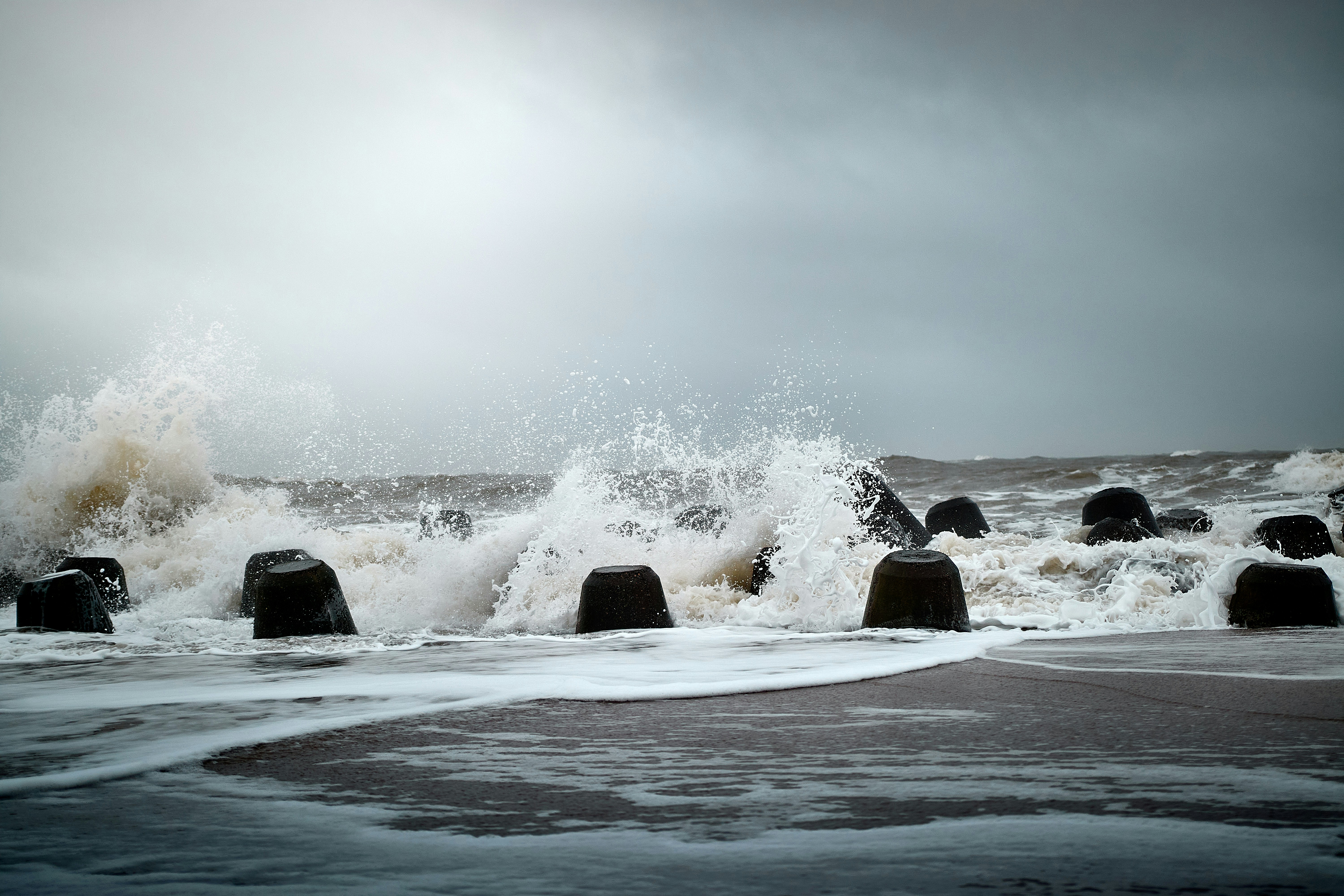Wave Break at a Sea Barrier: Concrete Stumps Defy the Tempest