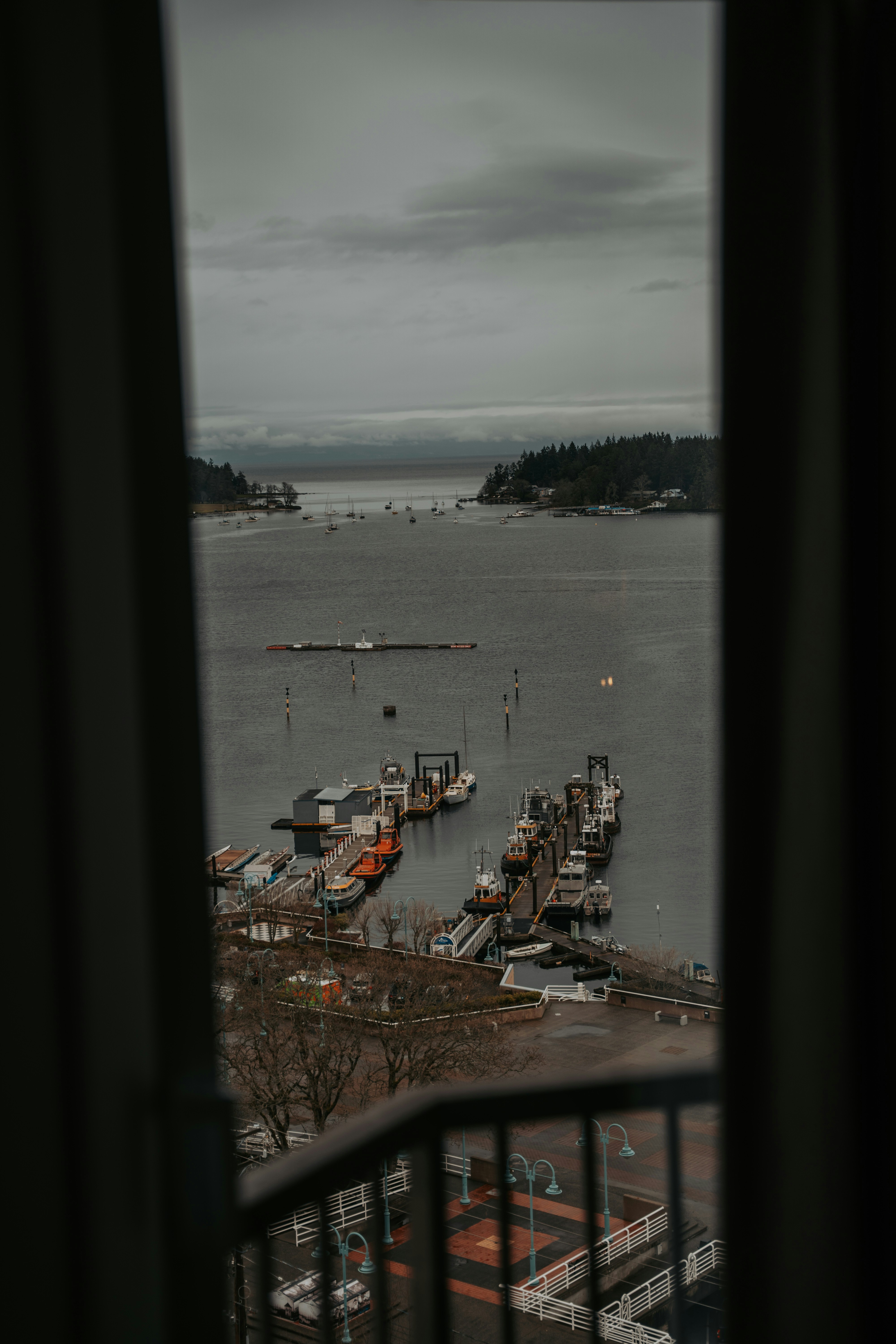 Harbor in Window Frame: Boats Nestled Along a Quiet Dock