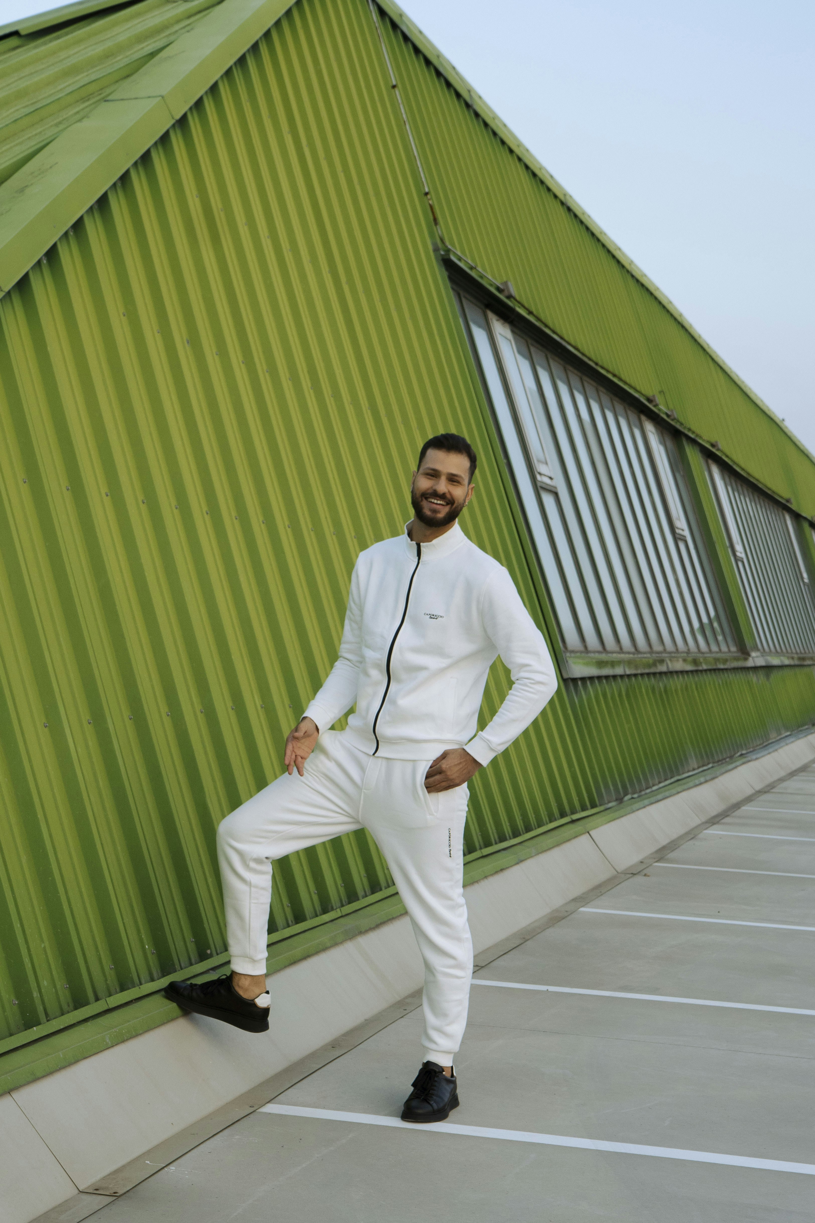 Stride of Color: A Man in White Against a Lime Wall