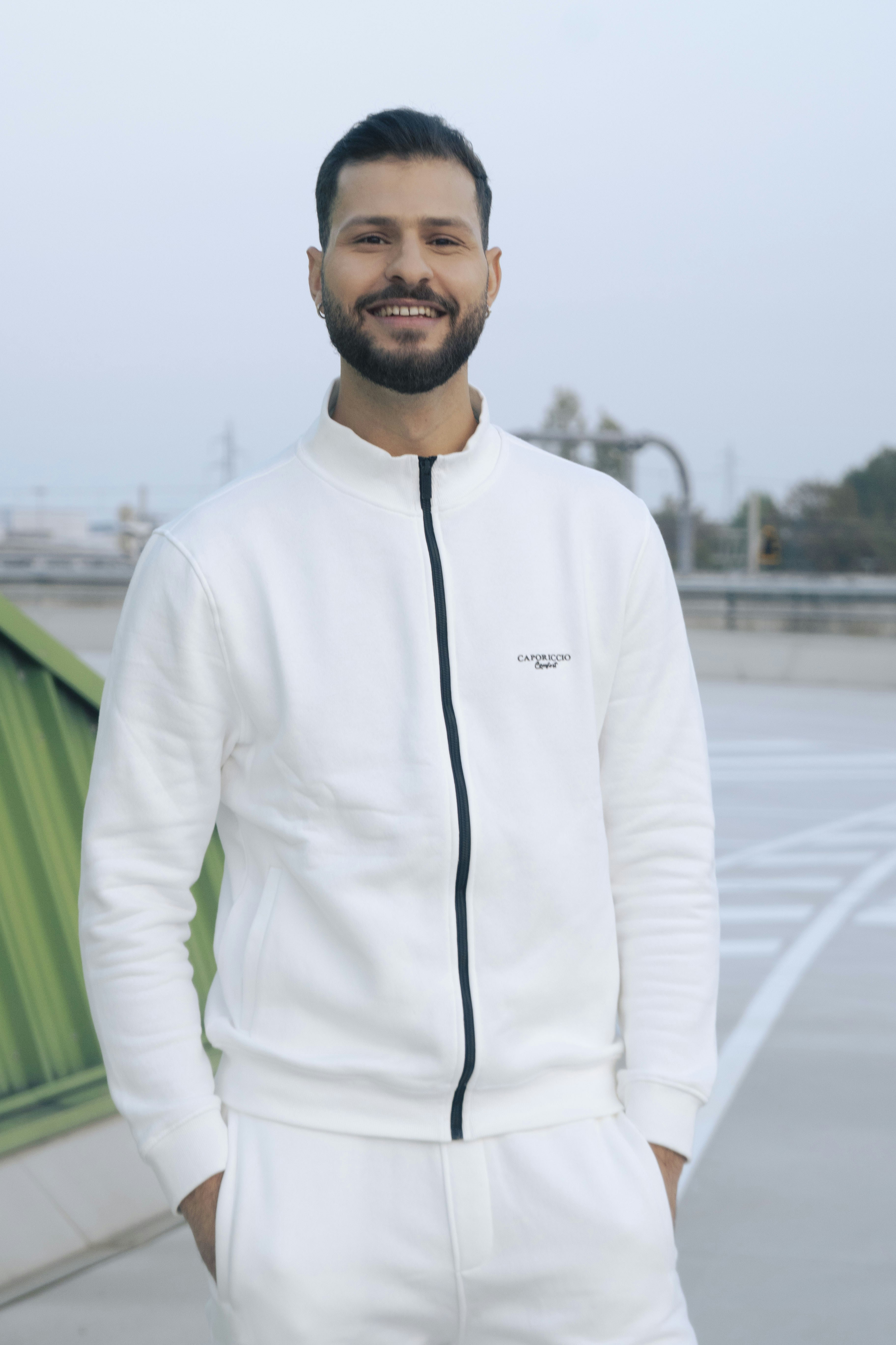 Urban rooftop confidence: a man in white on a misty morning