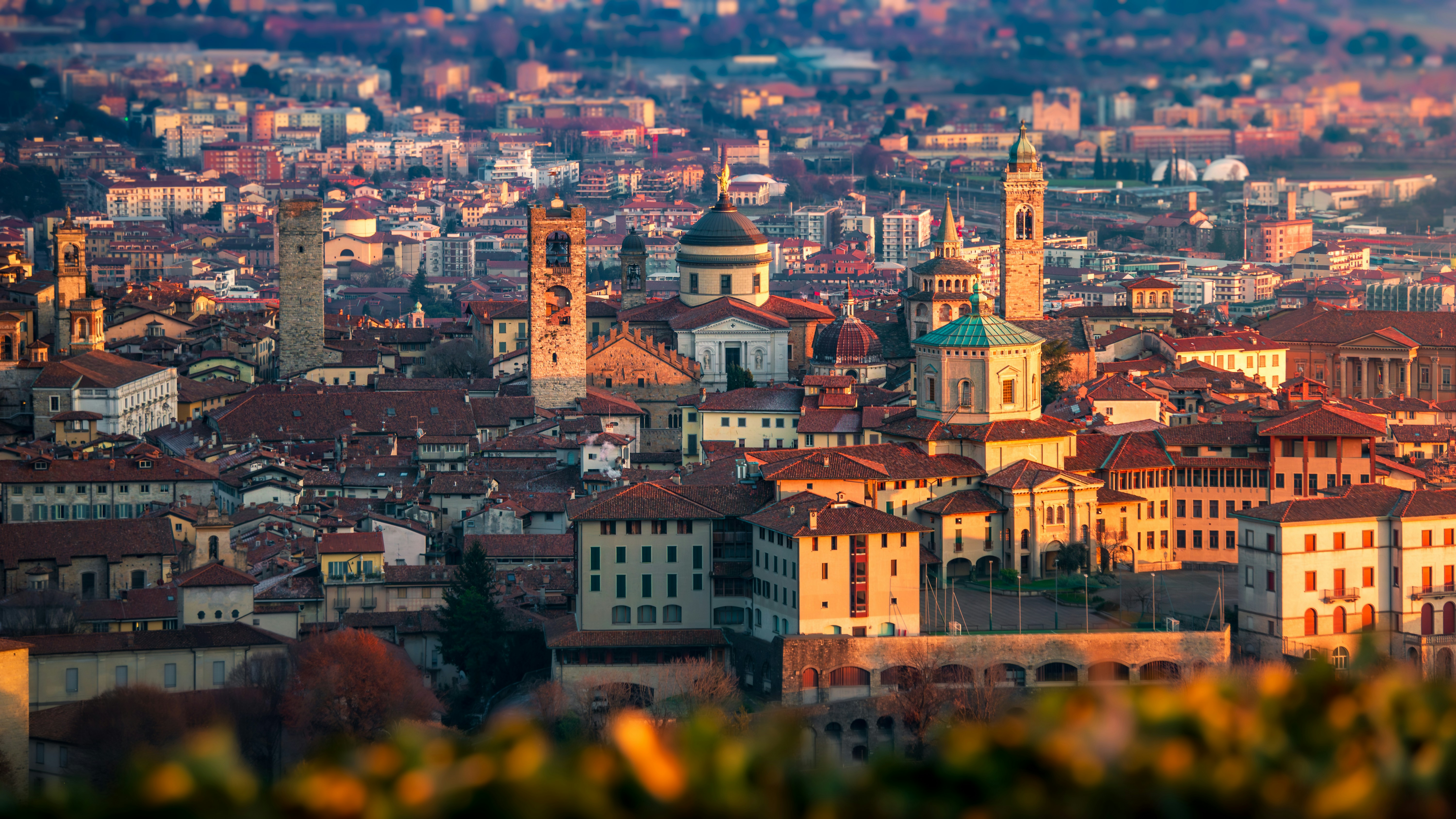 Golden hour illuminates historic italian cityscape with rolling hills ...