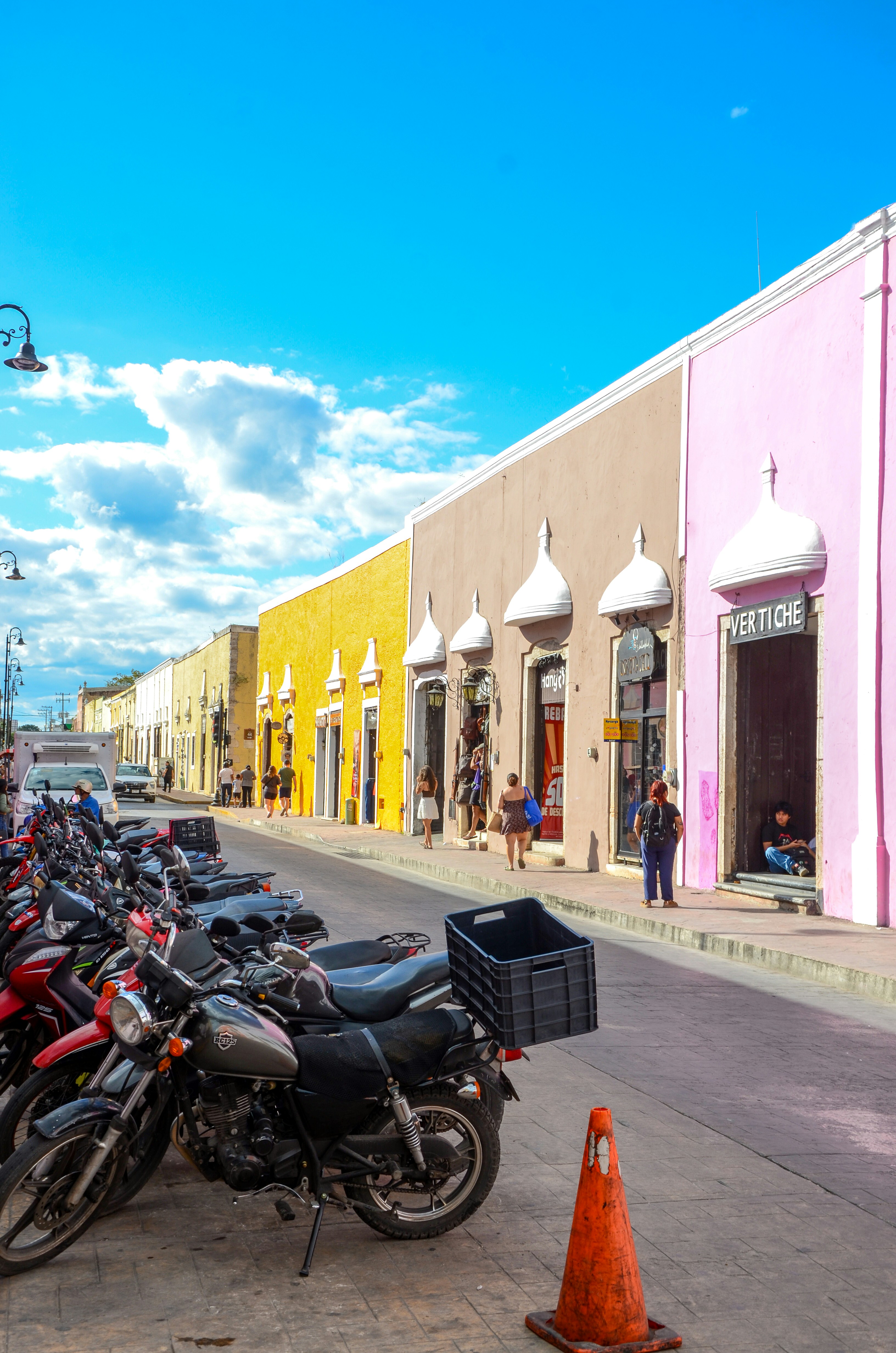 Colorful Calle: A Row of Neon-Faceted Shops Along a Bright Street