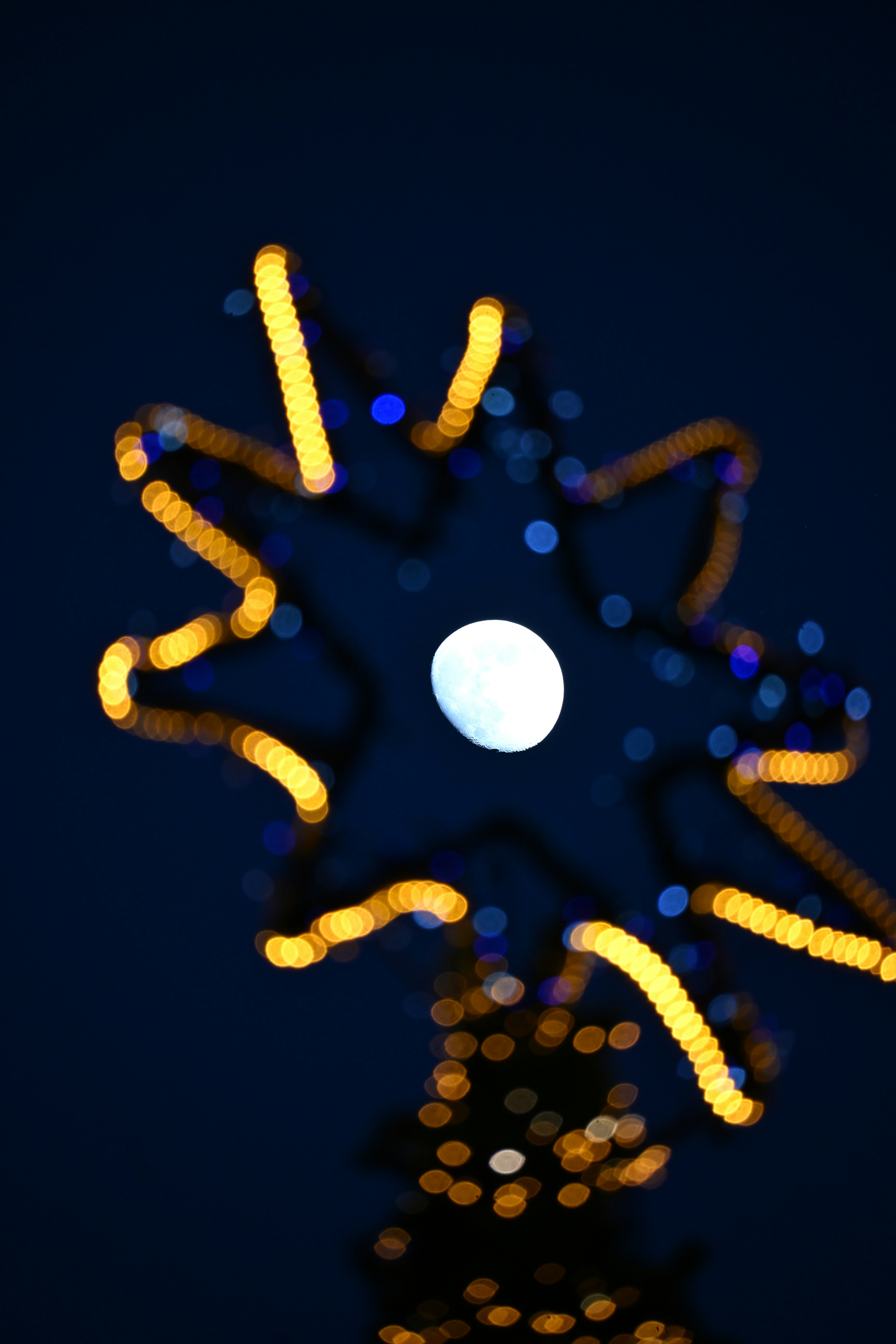 Moonlit Carousel: Neon Starburst Beneath a Blurred Night Sky