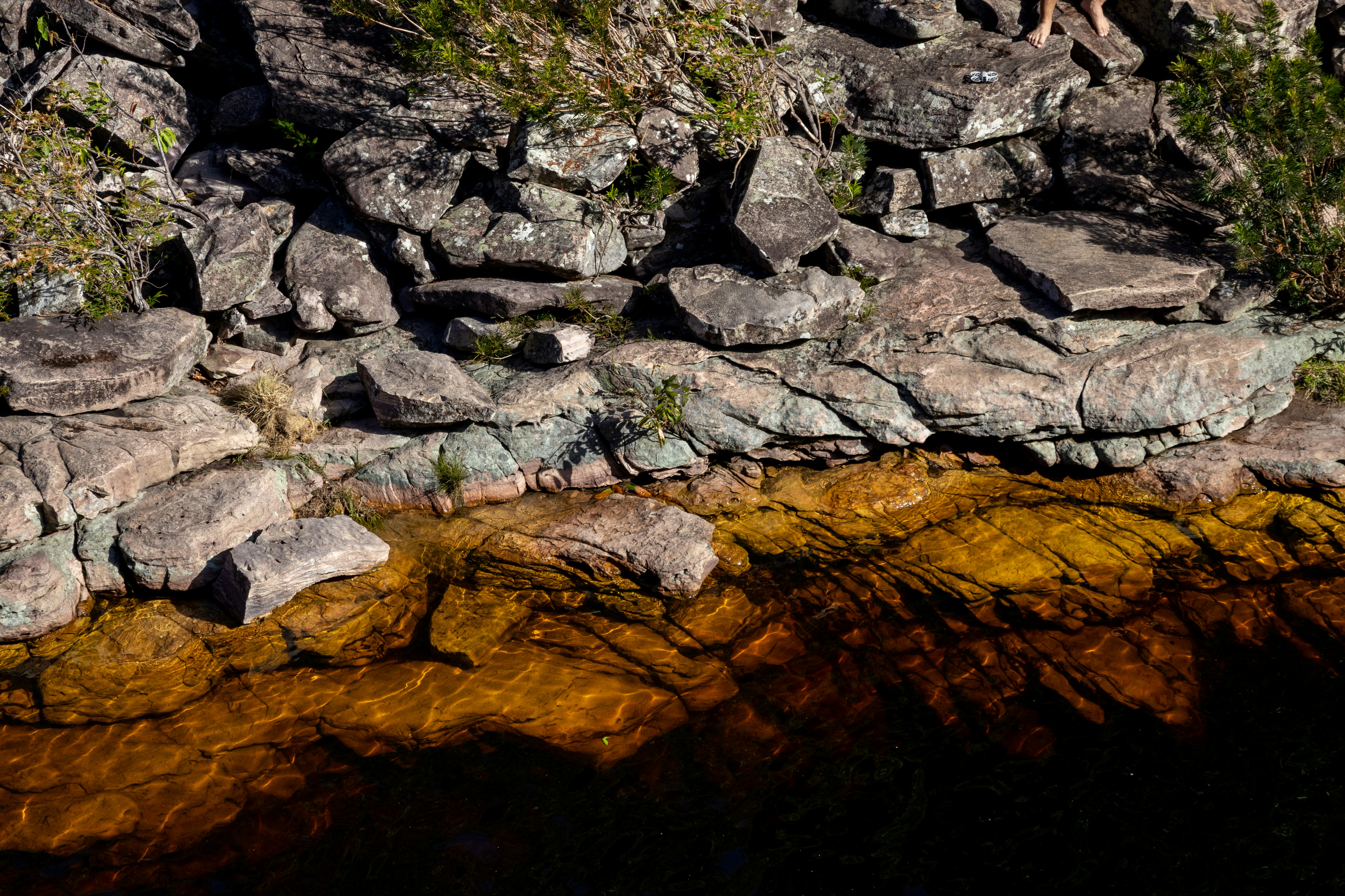 Rugged shoreline meets sunset-tinged rock strata