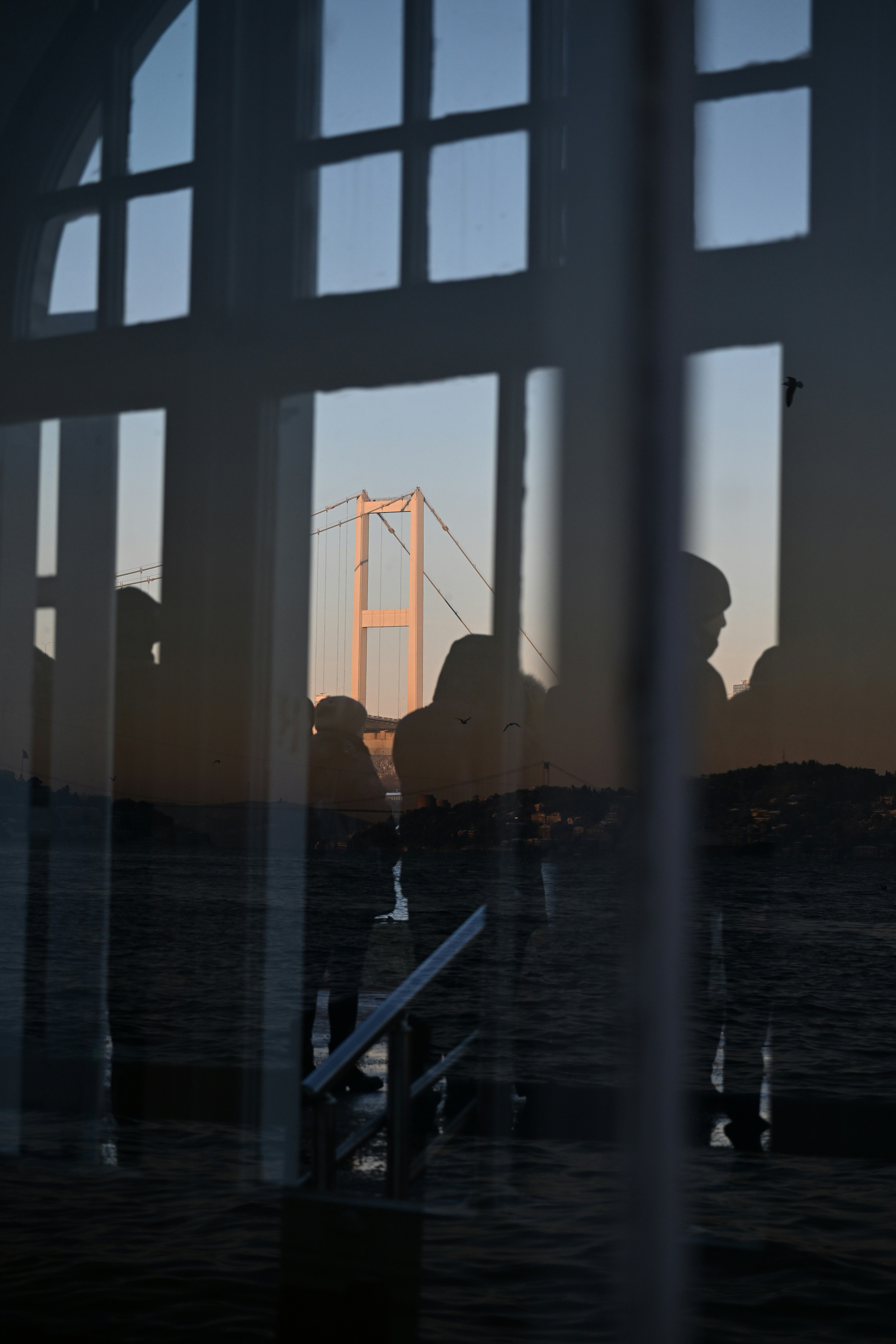 Through Glass and Steel: Sunset Reflections on a City Span