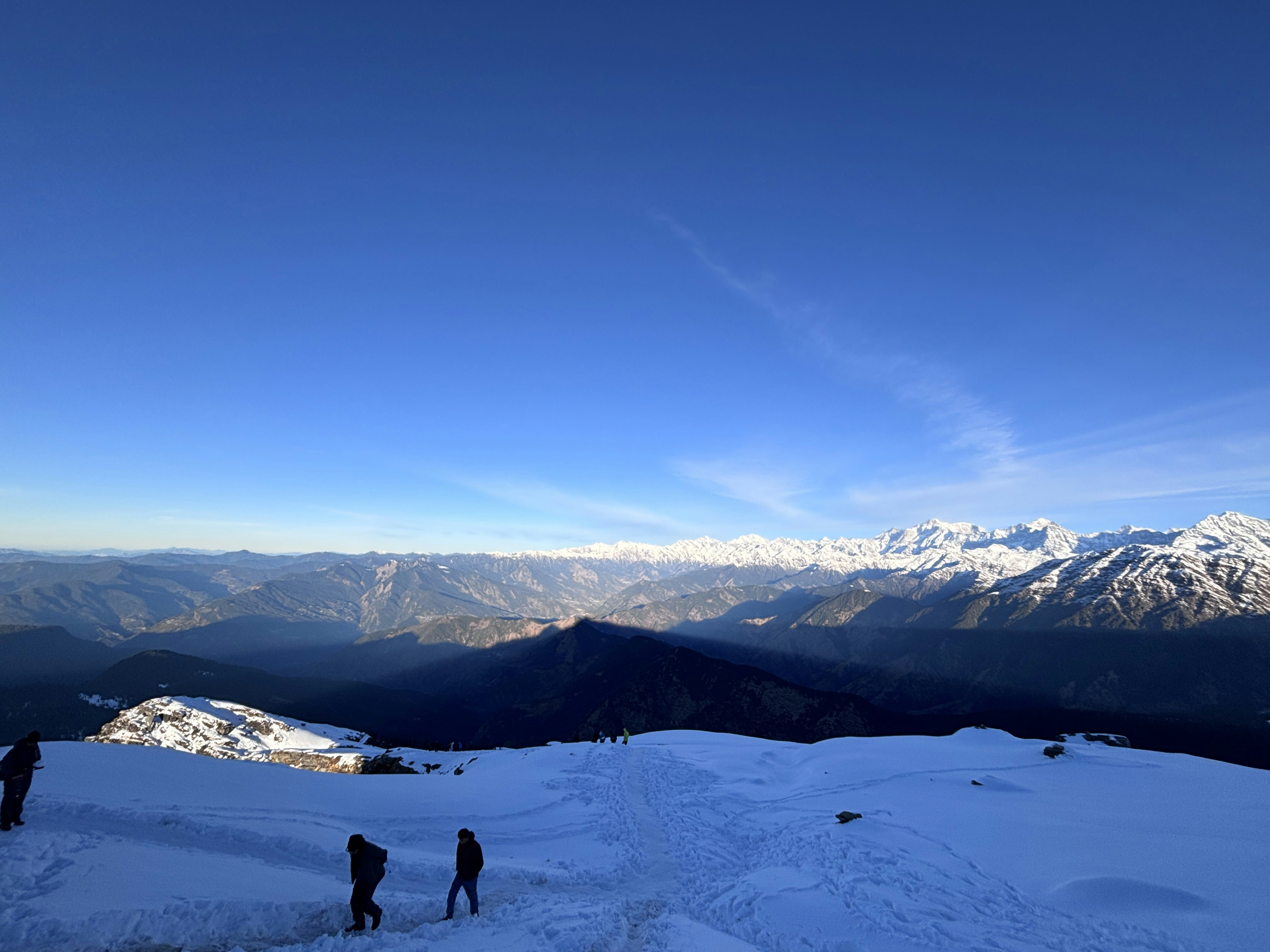 Snowbound Horizon: Alpine Silhouettes Beneath a Clear Blue Sky