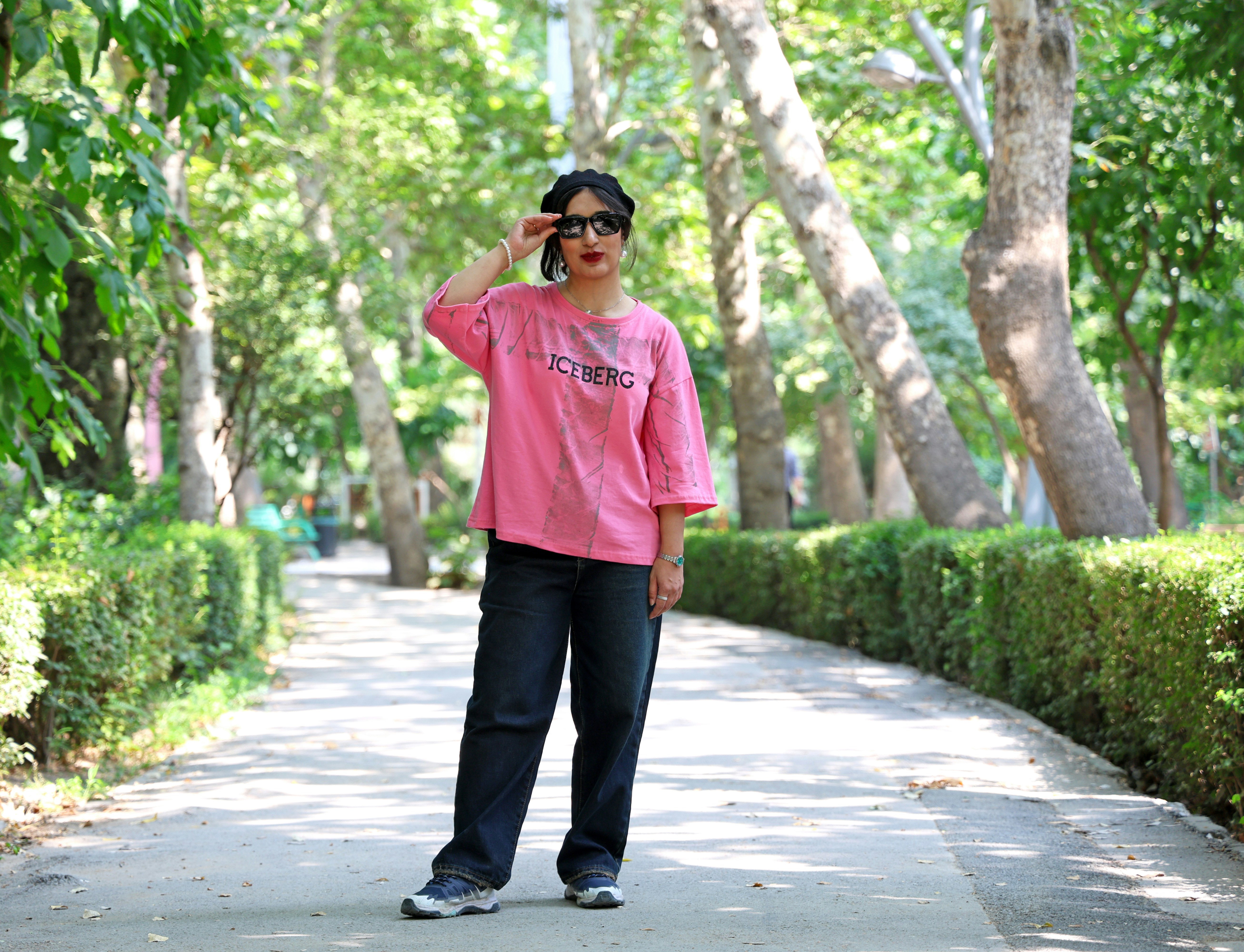 Pink Sweatshirt Stroll: A Quiet Moment Down a Tree-Lined Path
