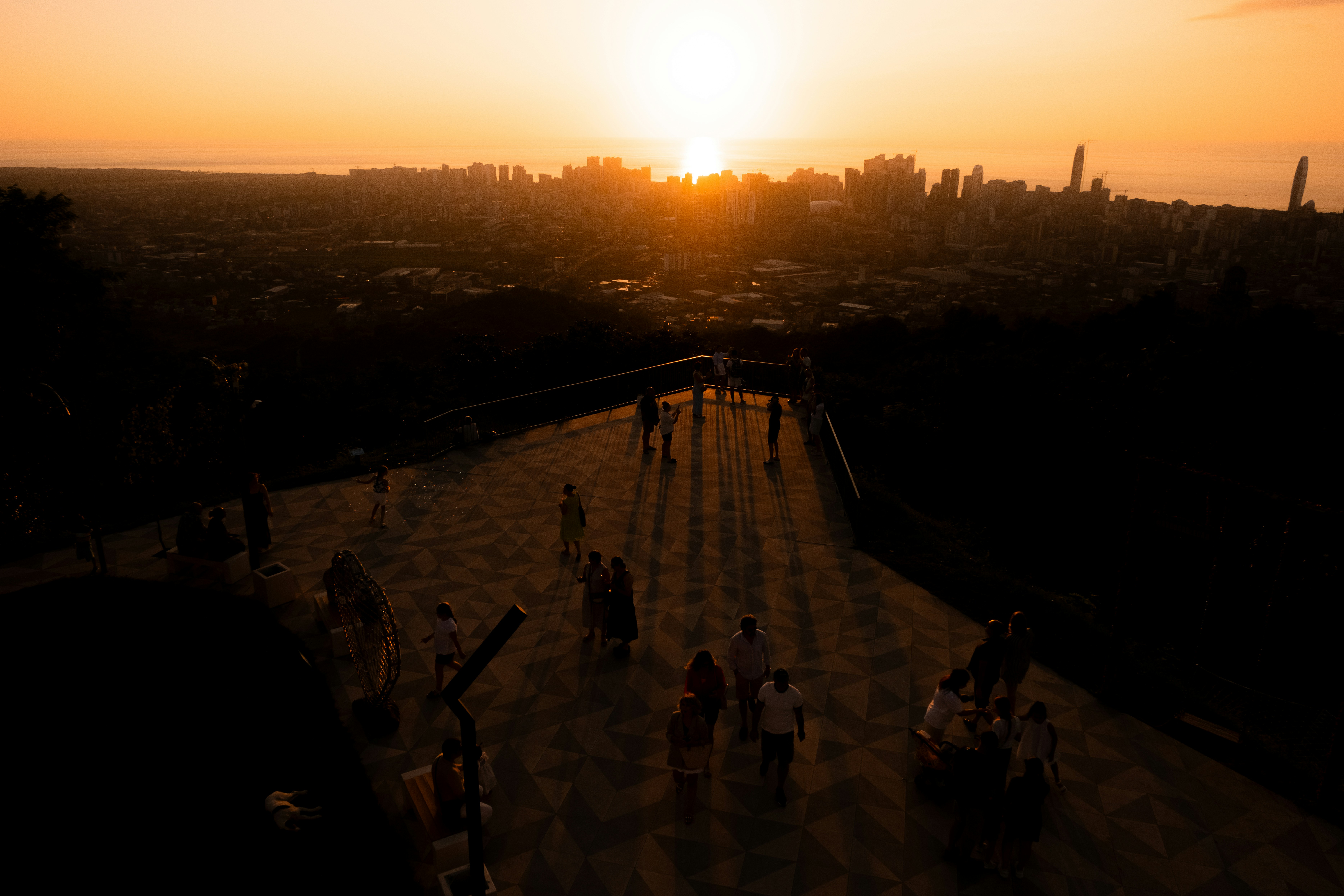 Sunset Terrace: silhouette of visitors against a glowing horizon