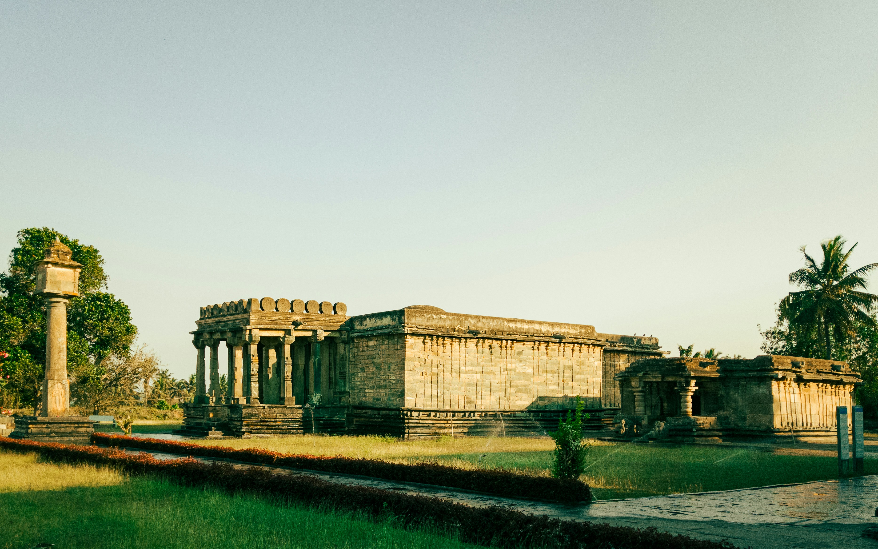 Ancient stone temple complex with a tall pillar.