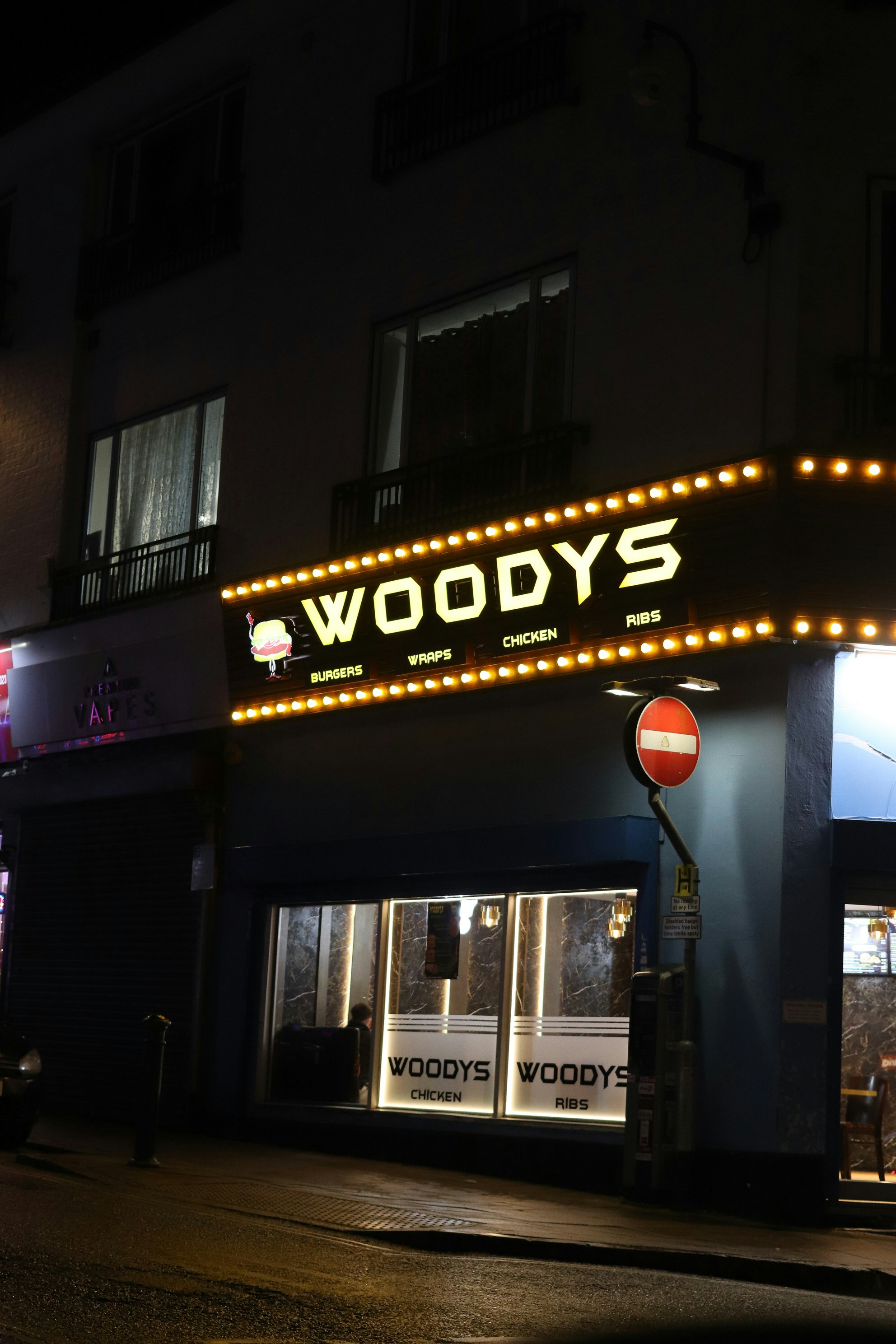 Neon Signage and Streetfront Glow at Woody's