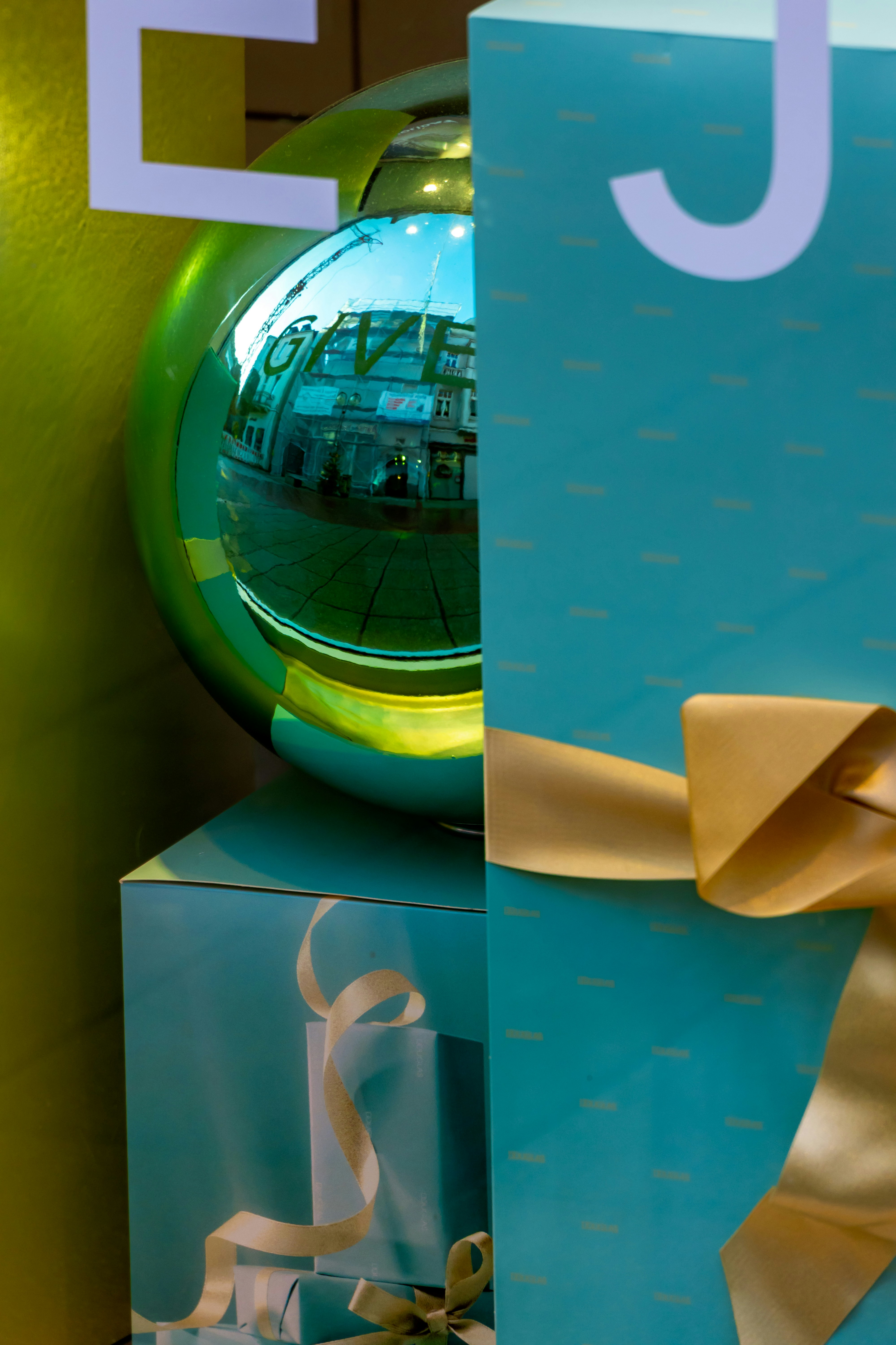Gleaming Gift: A cobalt ribboned scene framed by a reflective globe