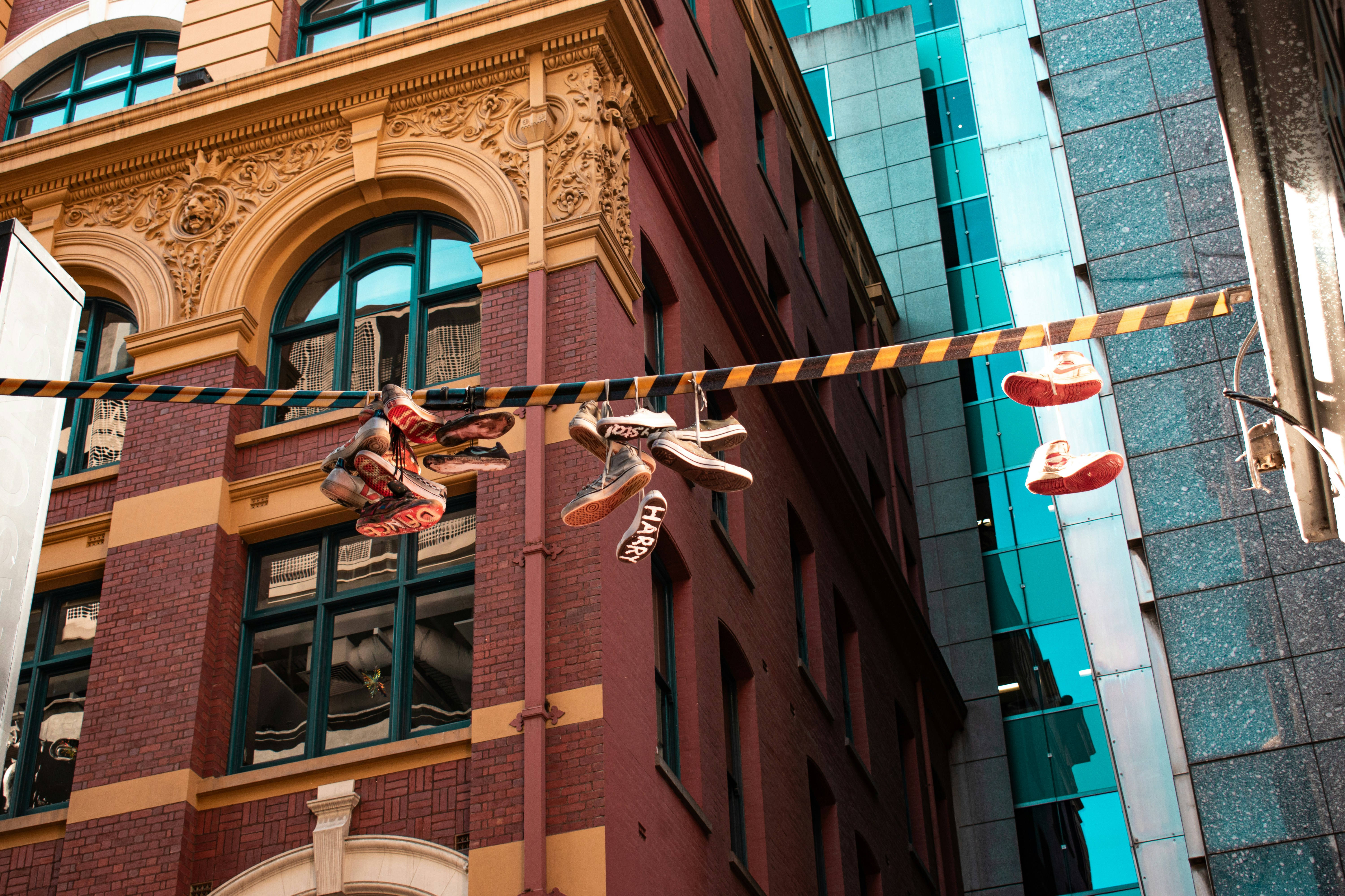 Shoes in Flight: A Row of Sneakers Dangled Across a City Bridge