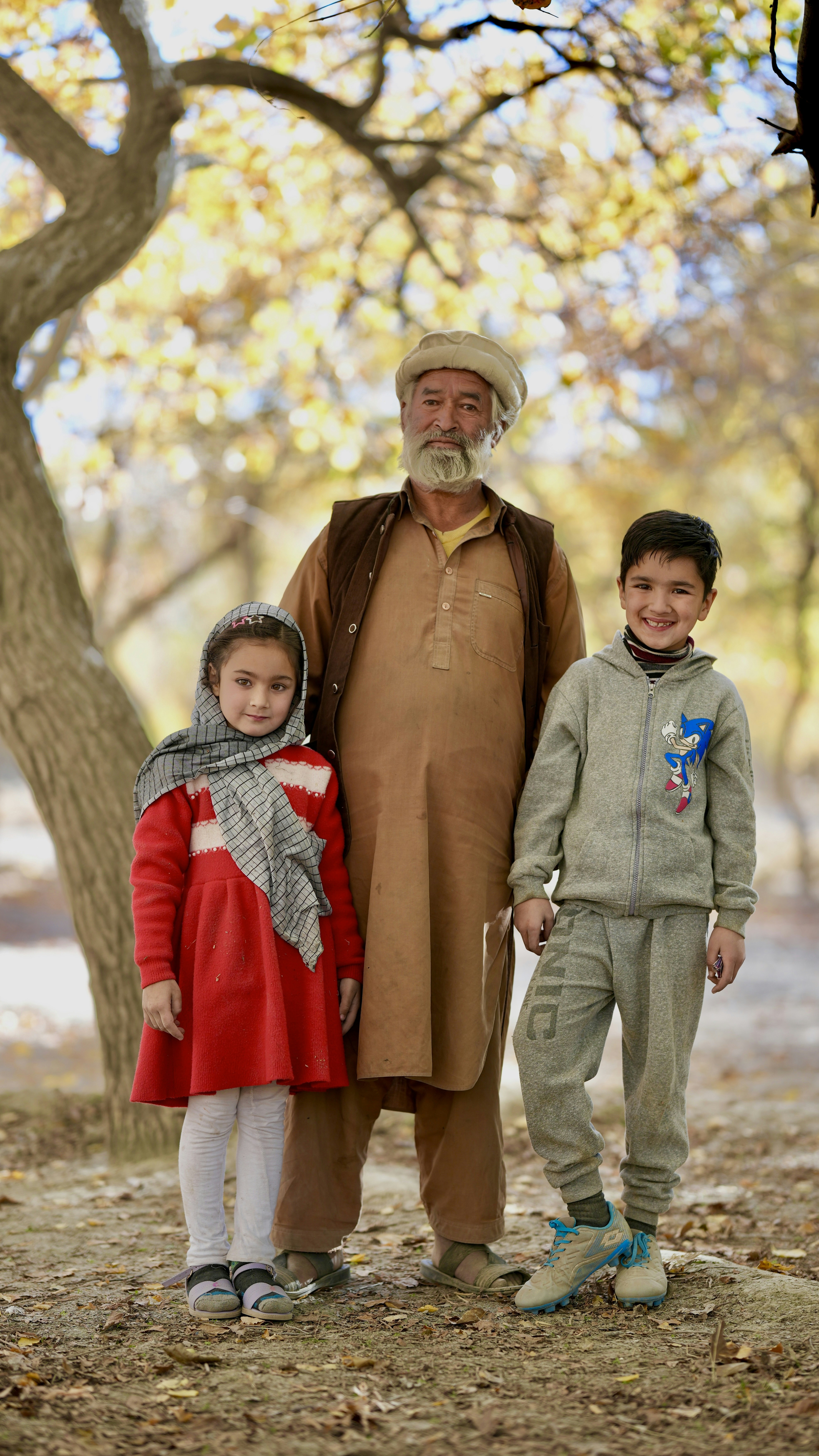 Grandfather and Grandchildren in Autumn Light
