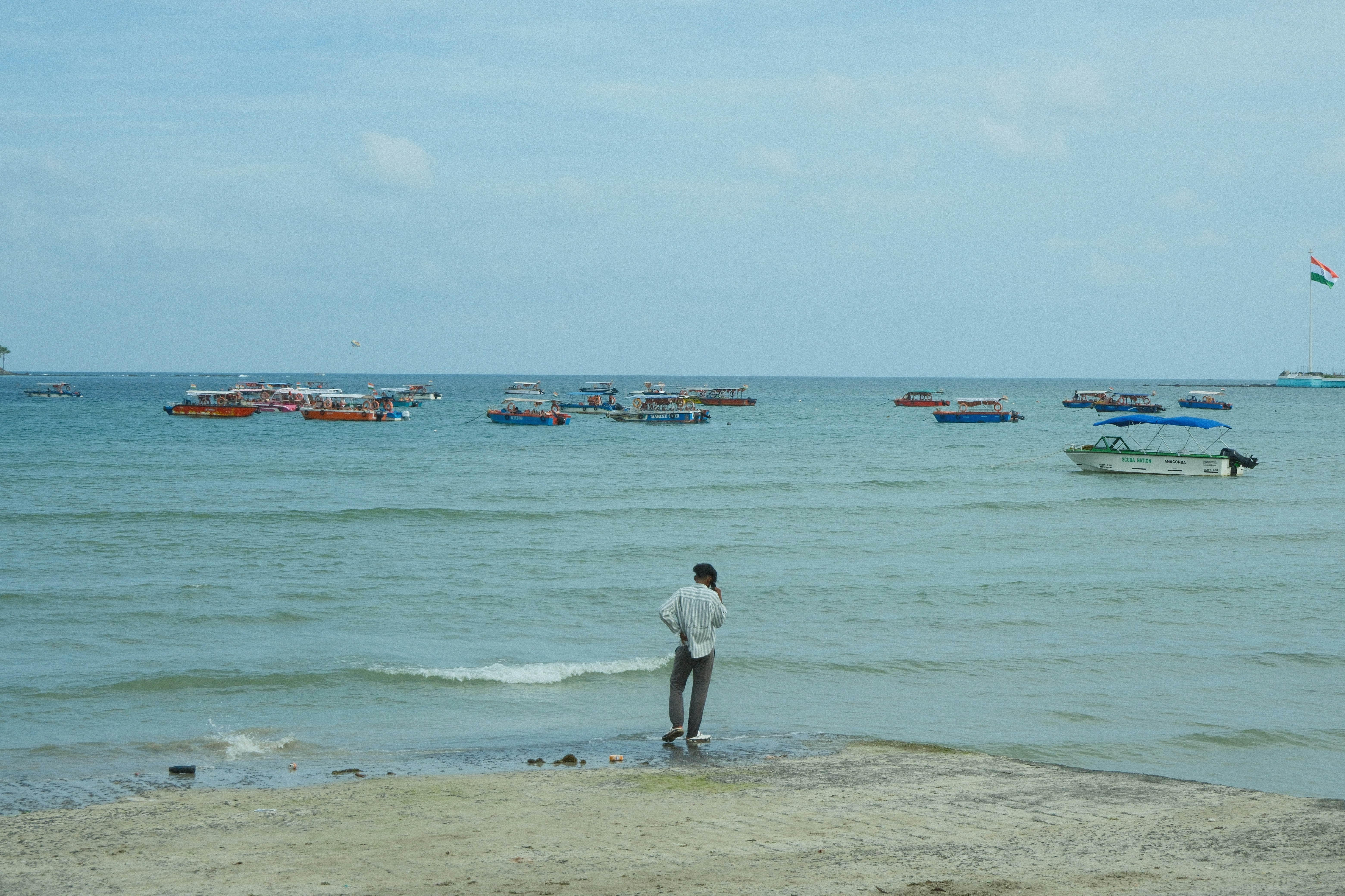 Solo Angler at the Shoreline: Quiet Resolve Beneath an Oceanic Horizon
