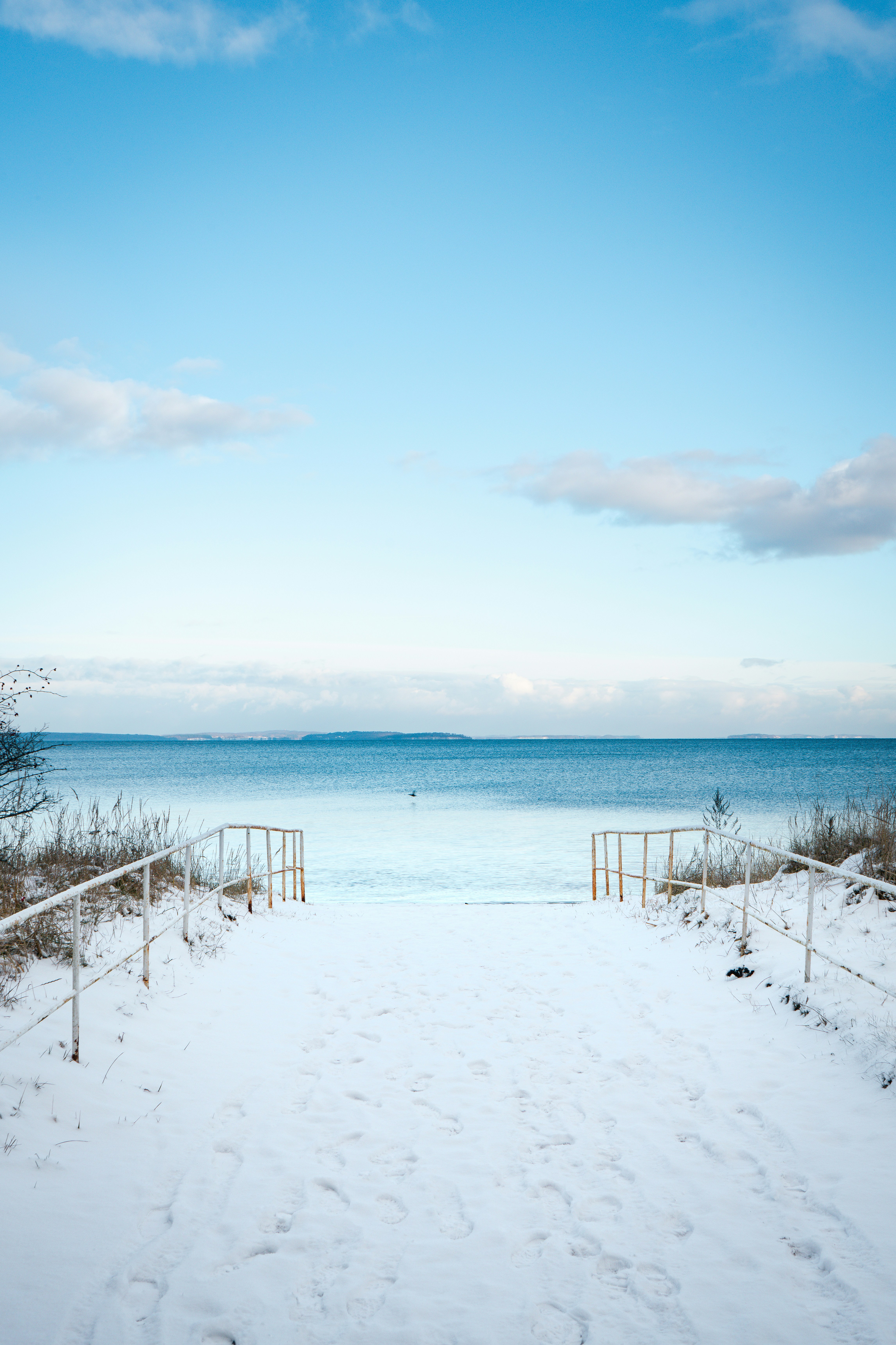 Snowy Ocean Pathway to Calm Waters