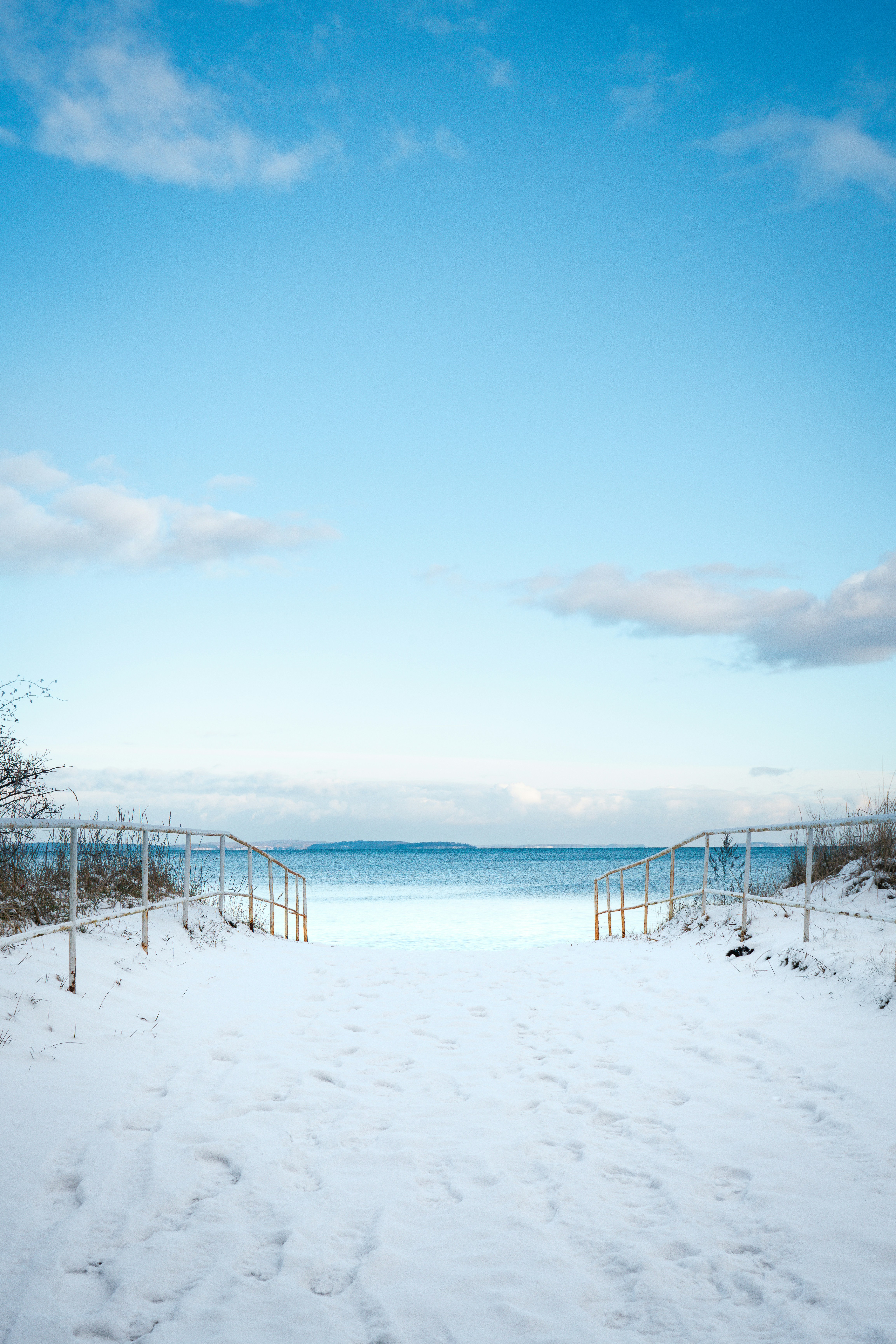 Snowbound Pier to the Horizon: A Quiet Beach Path in Winter Light