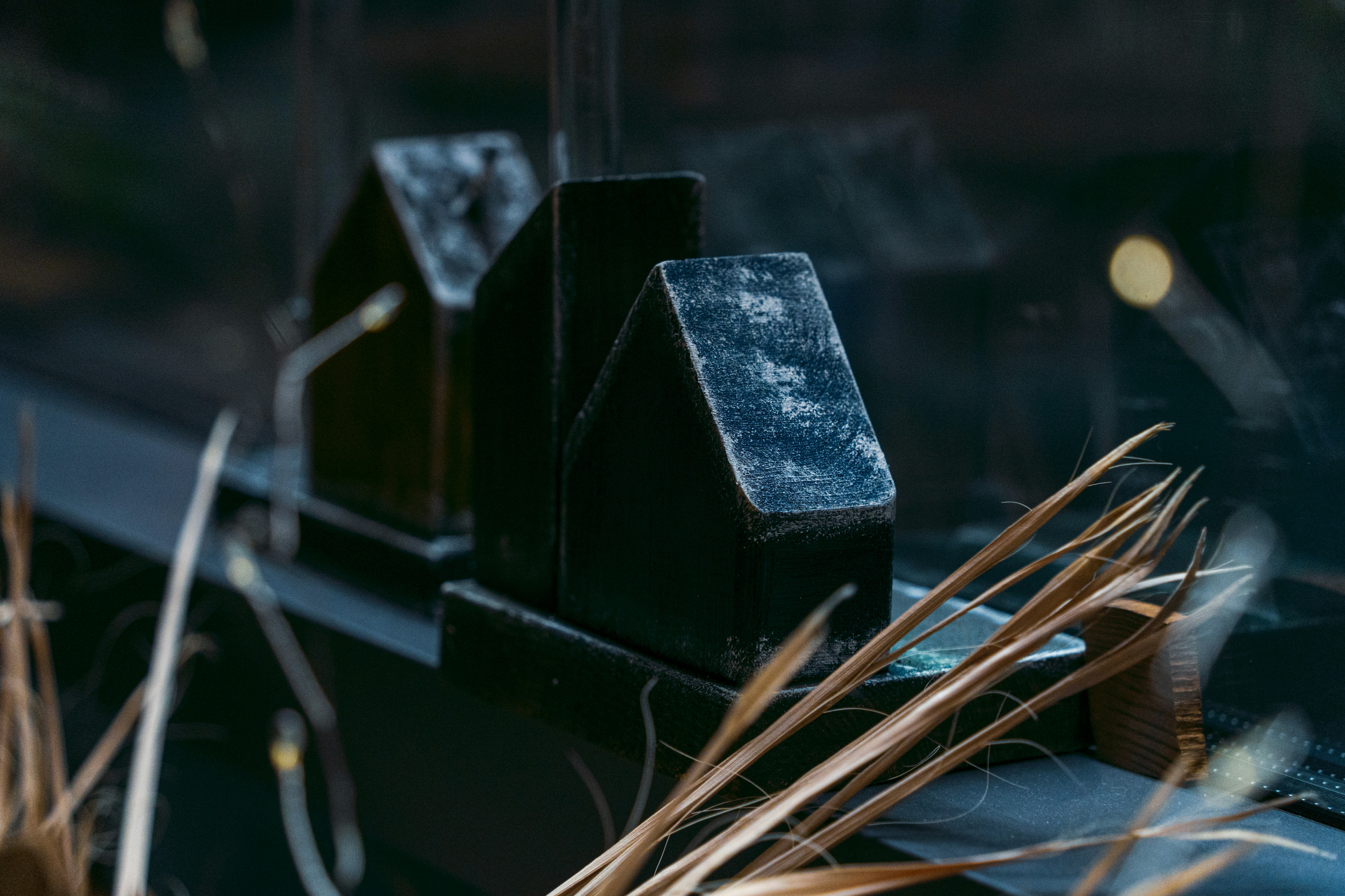 Industrial Iron Peaks Against Fronds and Glass