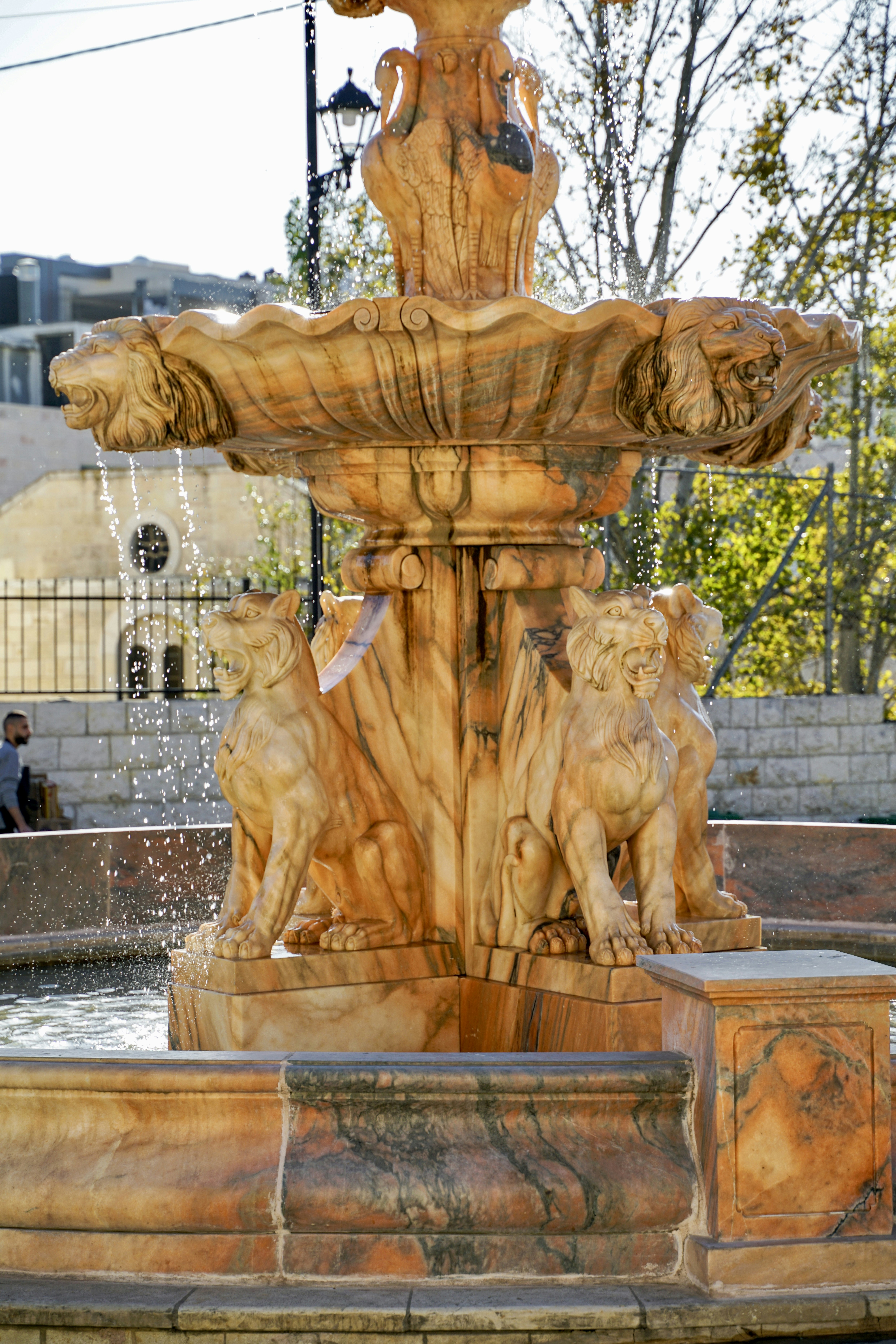 Golden Fountain Sculpture: Lion Lions and Cascading Water in Noon Light