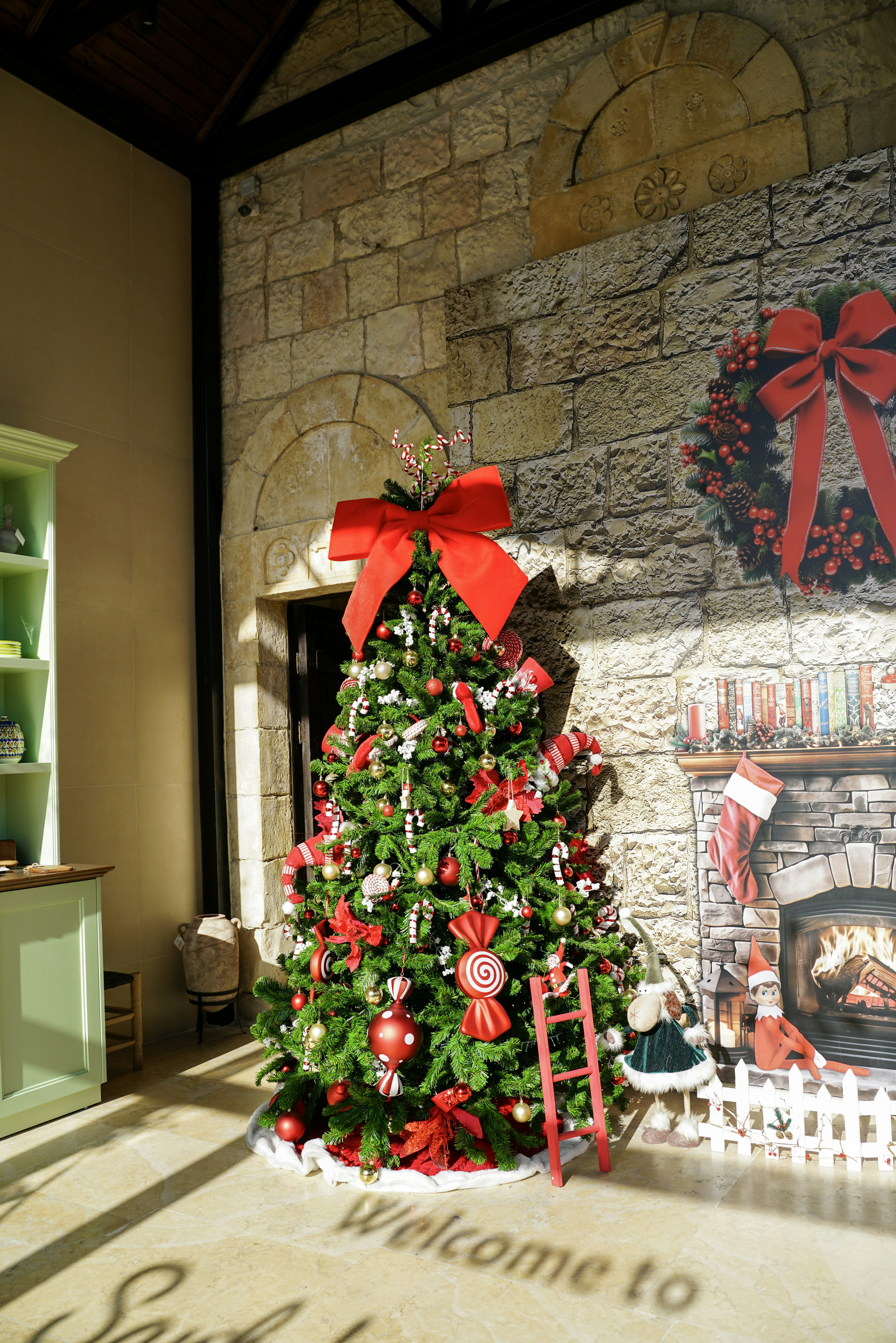 Crimson bow centerpiece: a festive Christmas tree framed by a warm stone arch