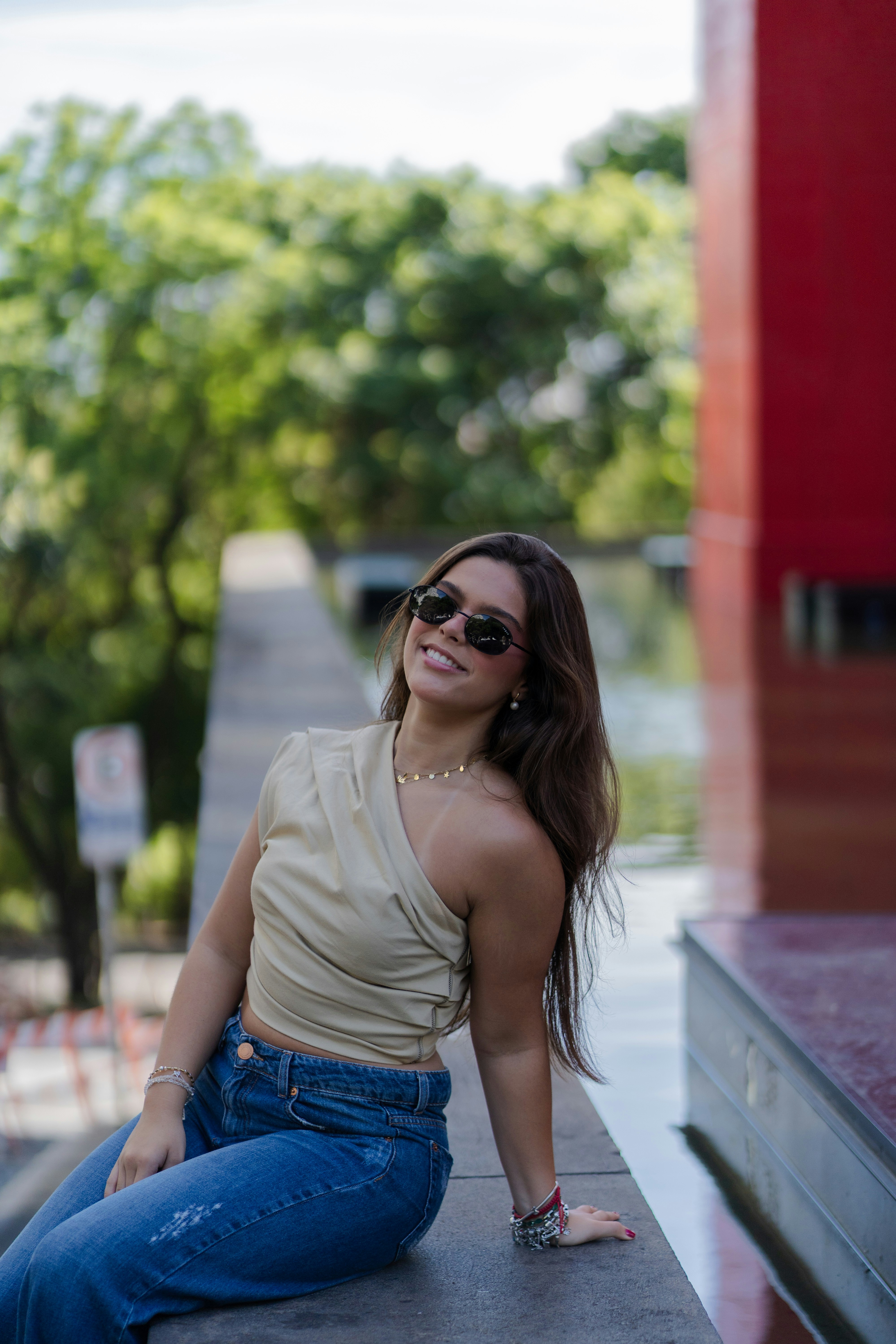 Sunlit Confidence: A Casual Portrait by the Water Feature