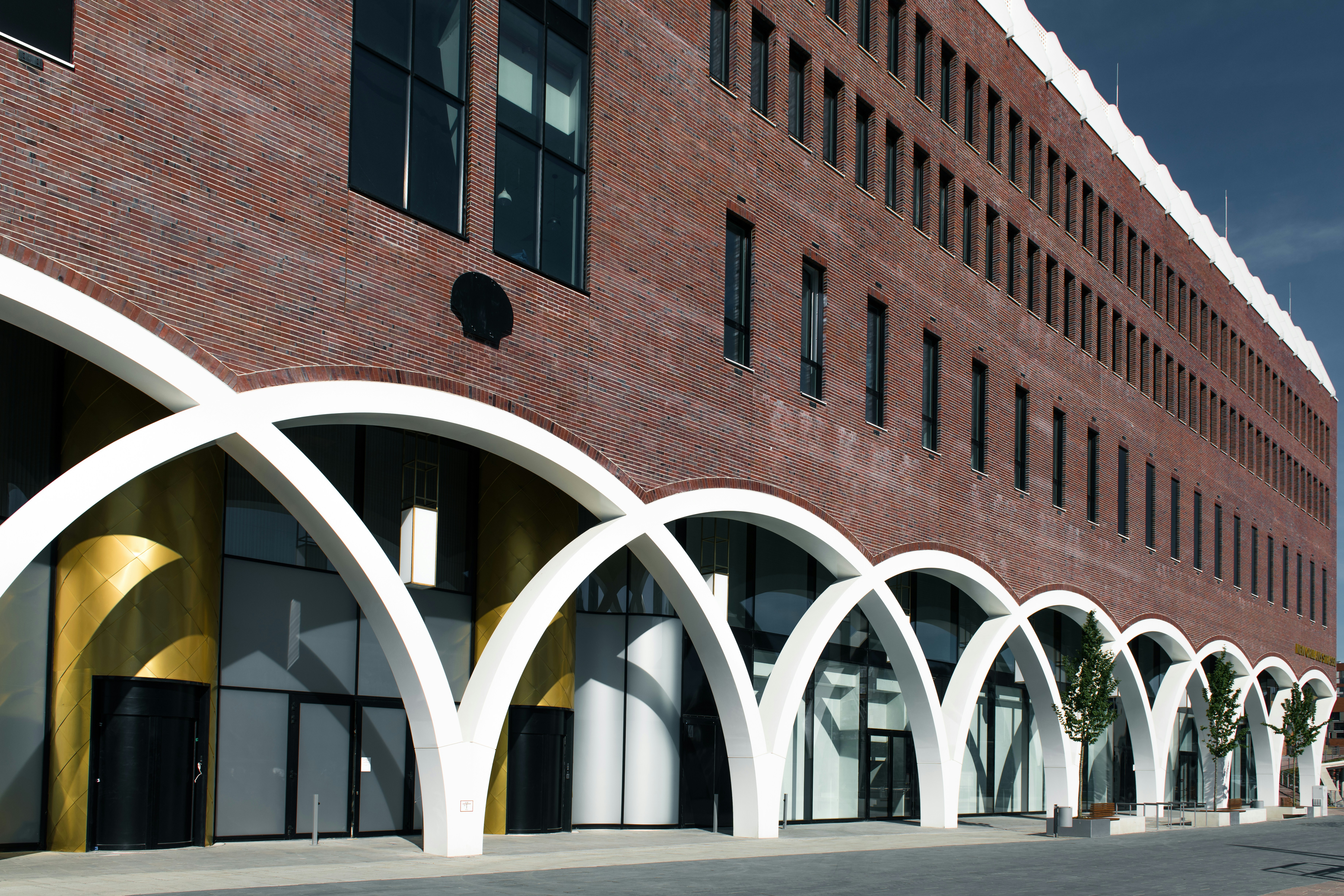 Arching White Arches Meet Brick Facade: A Modern Arcology
