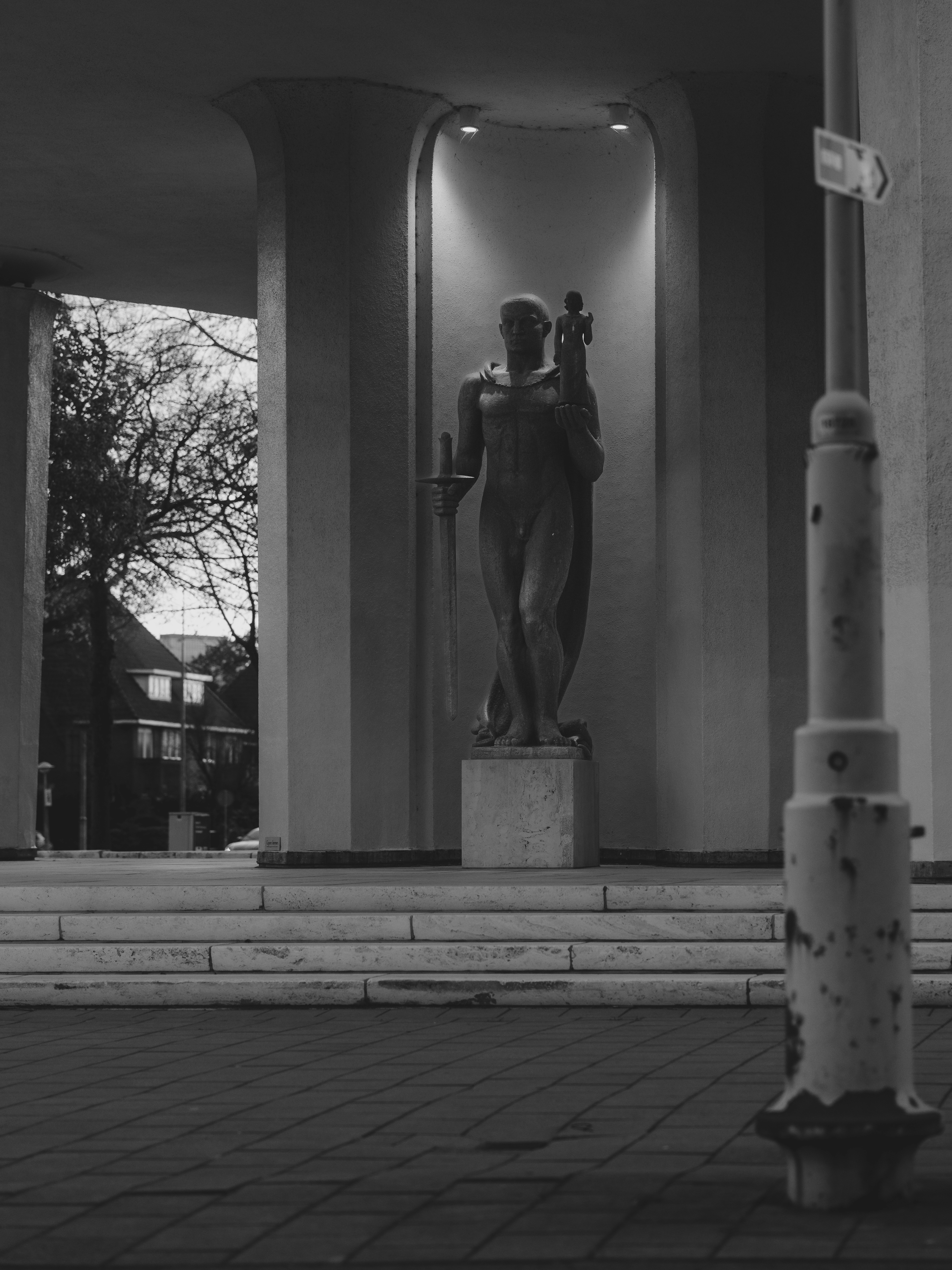 Statue of Dawn: A Lone Figure Guarding the Pillared Entrance