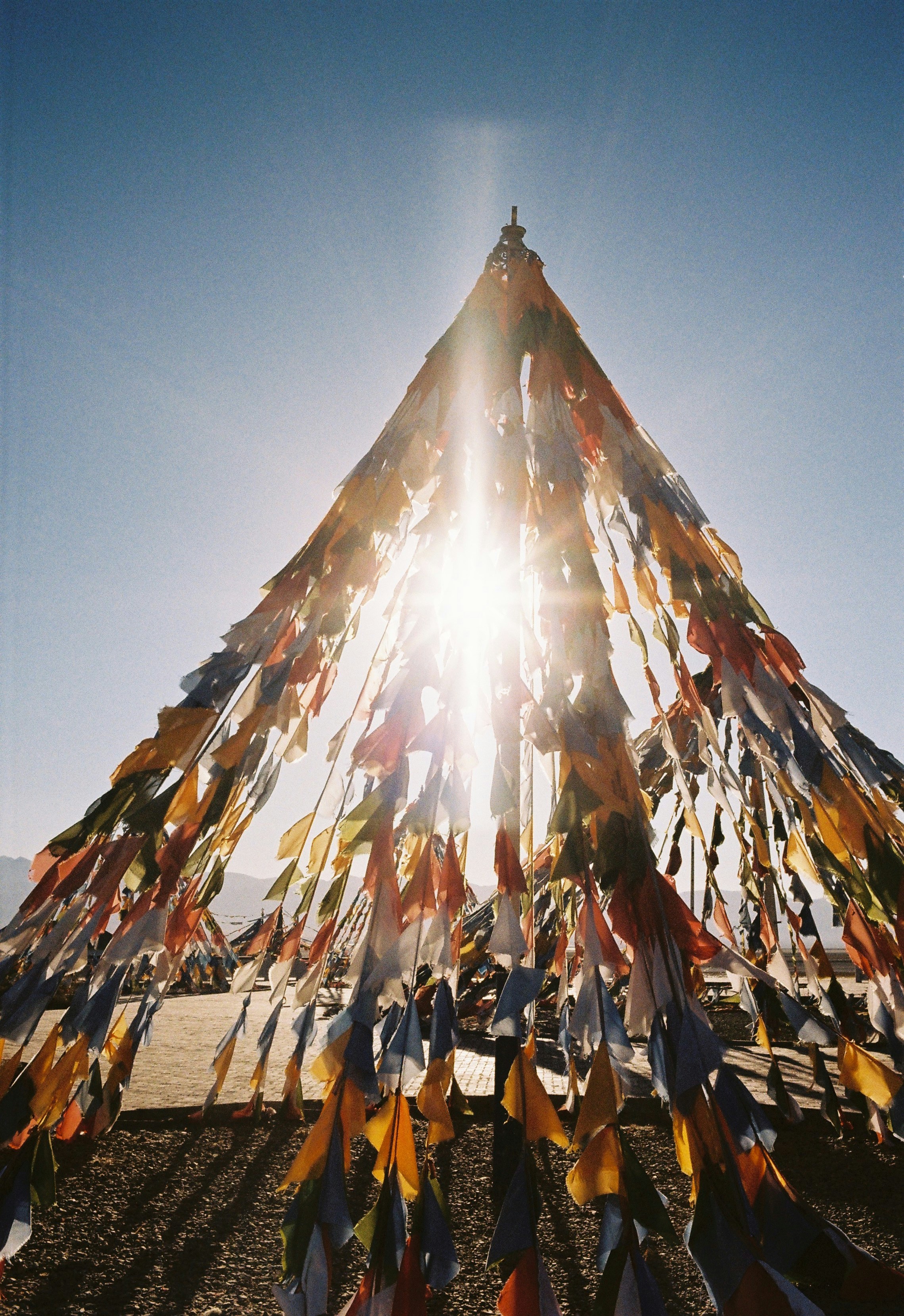Prayer Flags Reaching Toward the Sun Over a Wind-Kissed Plain