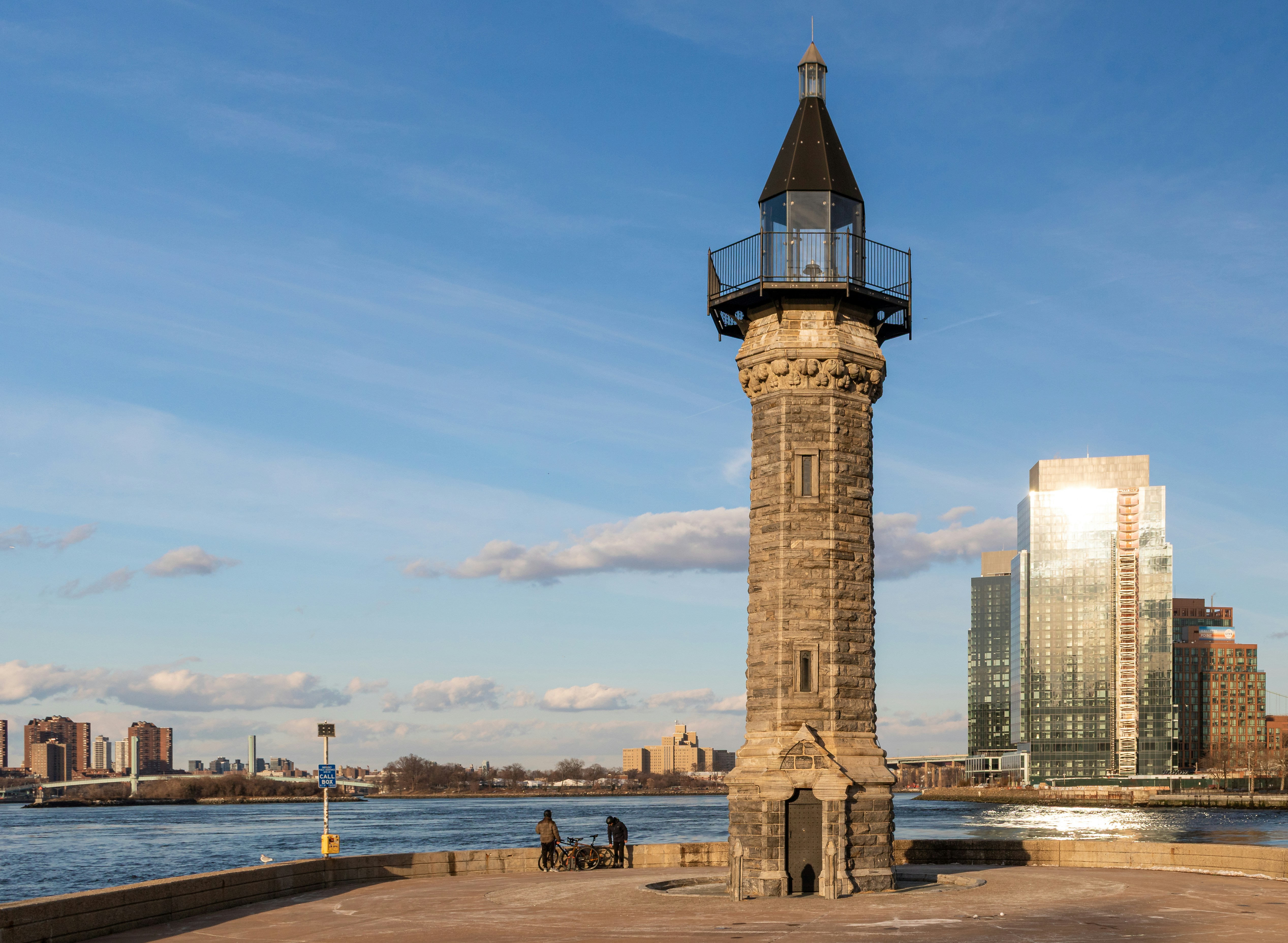 Beacon by the River: A Stone Tower Facing the Skyline