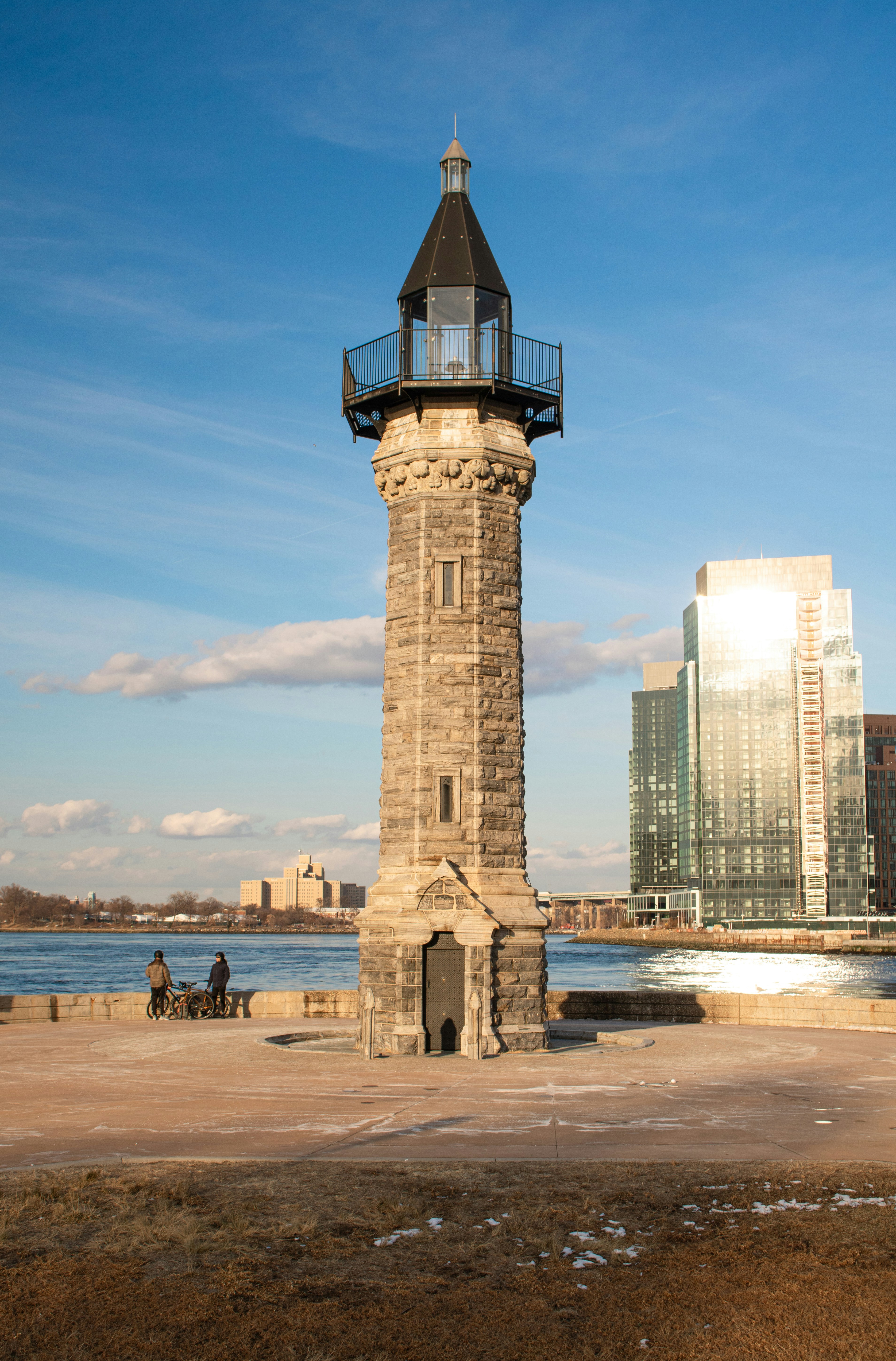 Harbor Beacon: The Stone Tower Against a Modern Glass Backdrop