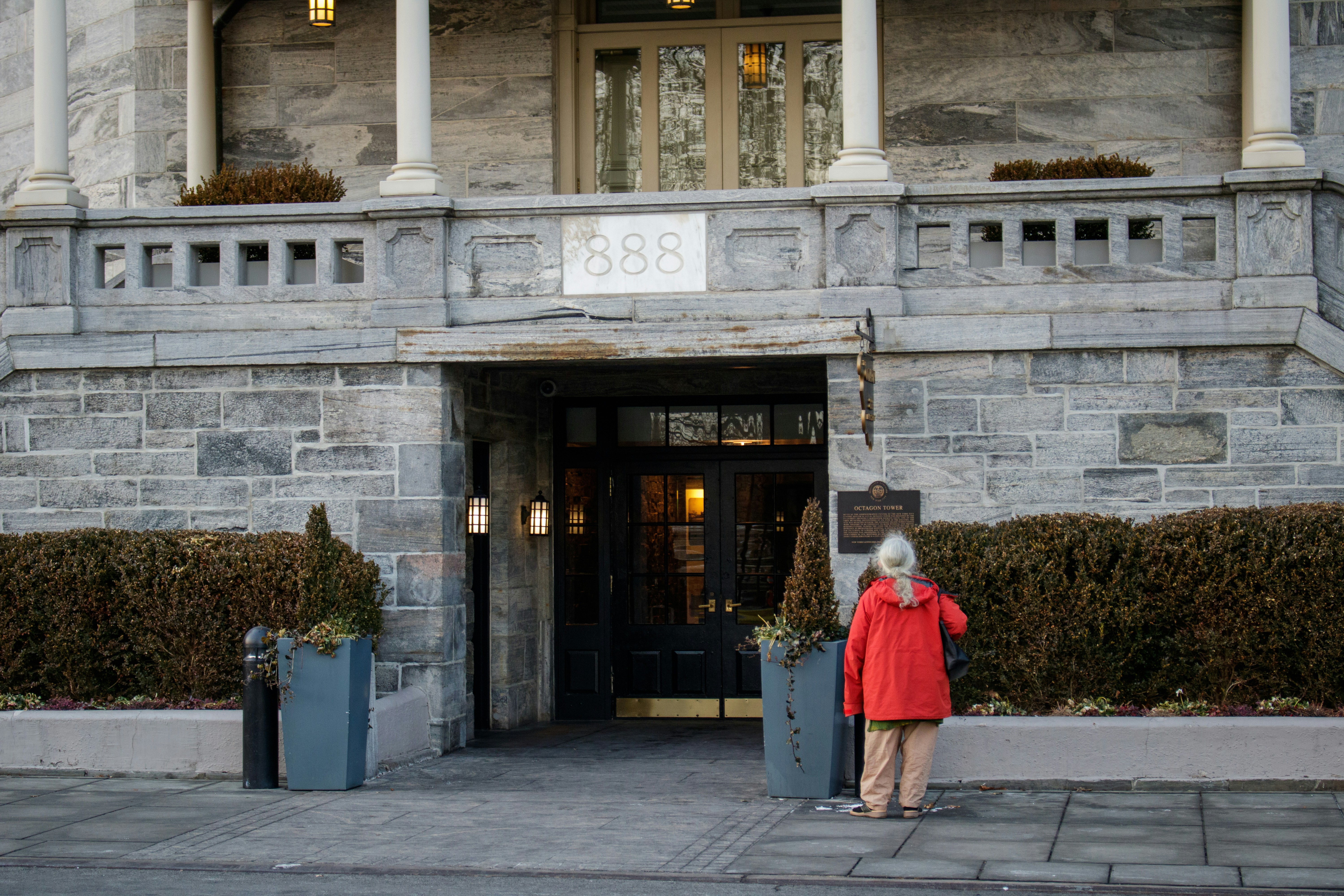 Red-Coat Sentinel at the Stone Entrance