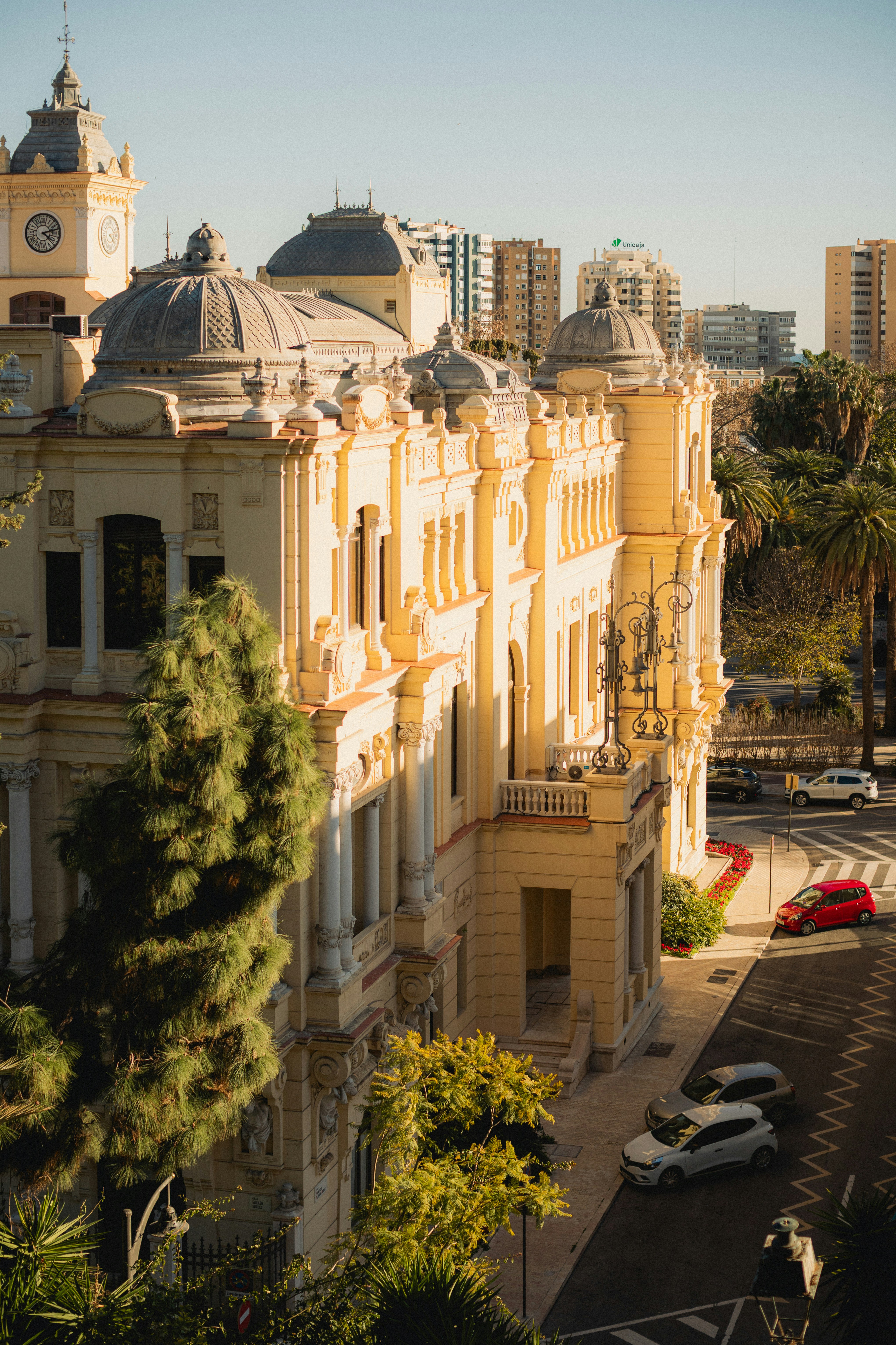 Golden Facade and Palm Shadows: A Sunlit City Hall Vista