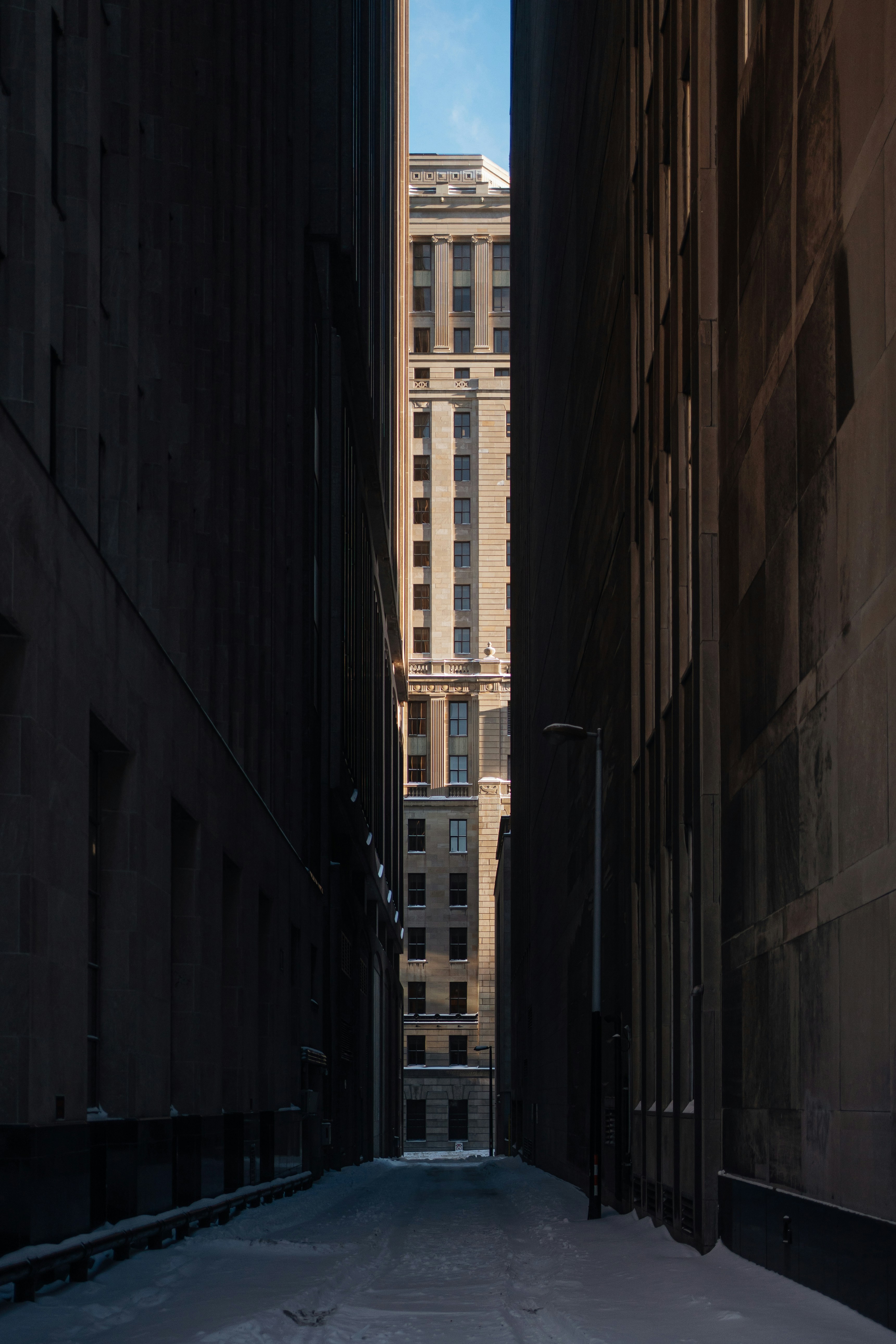 Light at the End: A Narrow Corridor to a Distant Facade