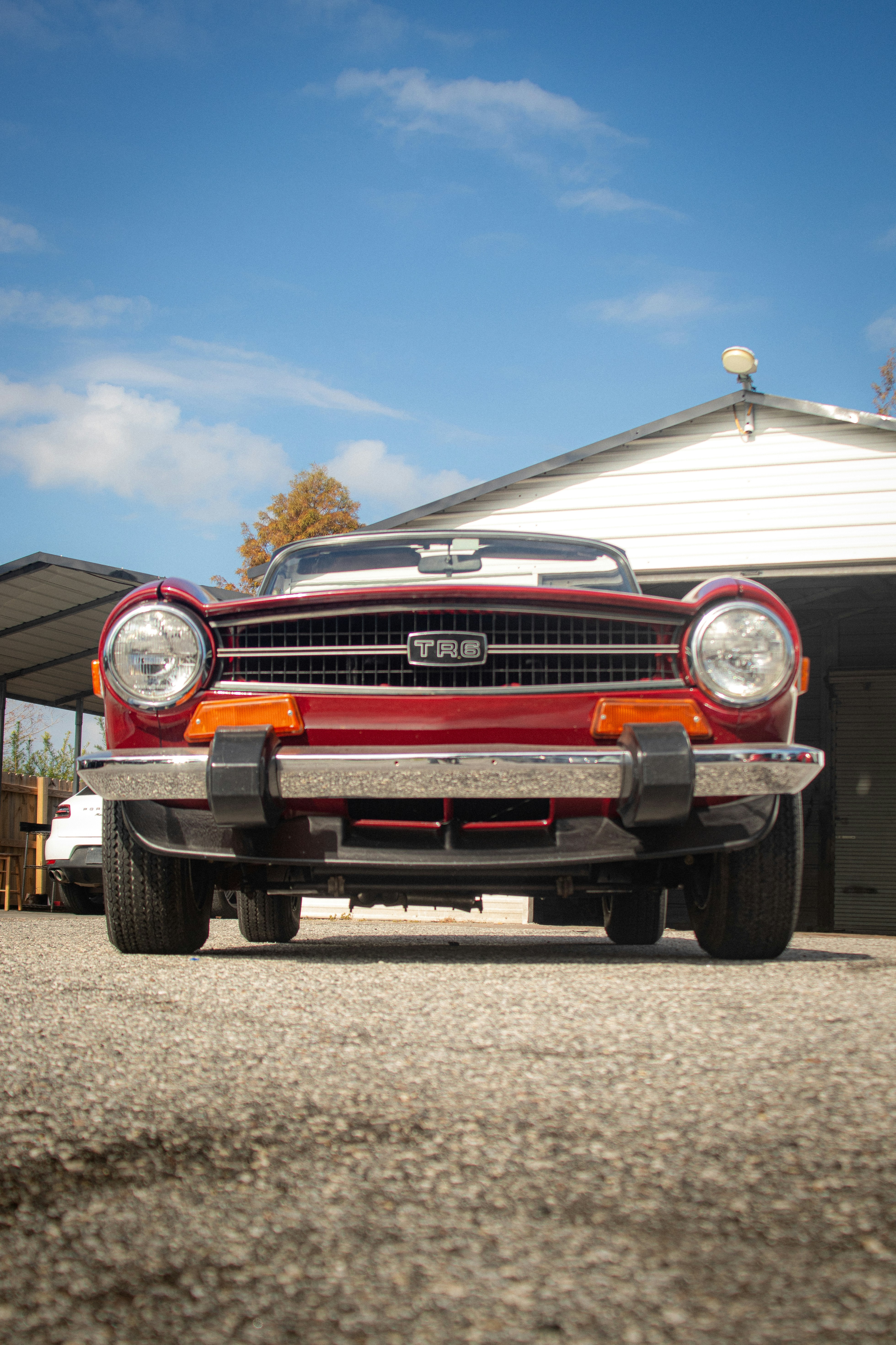 Front-and-Centers: The Red TR3 Beast Guarding the Driveway
