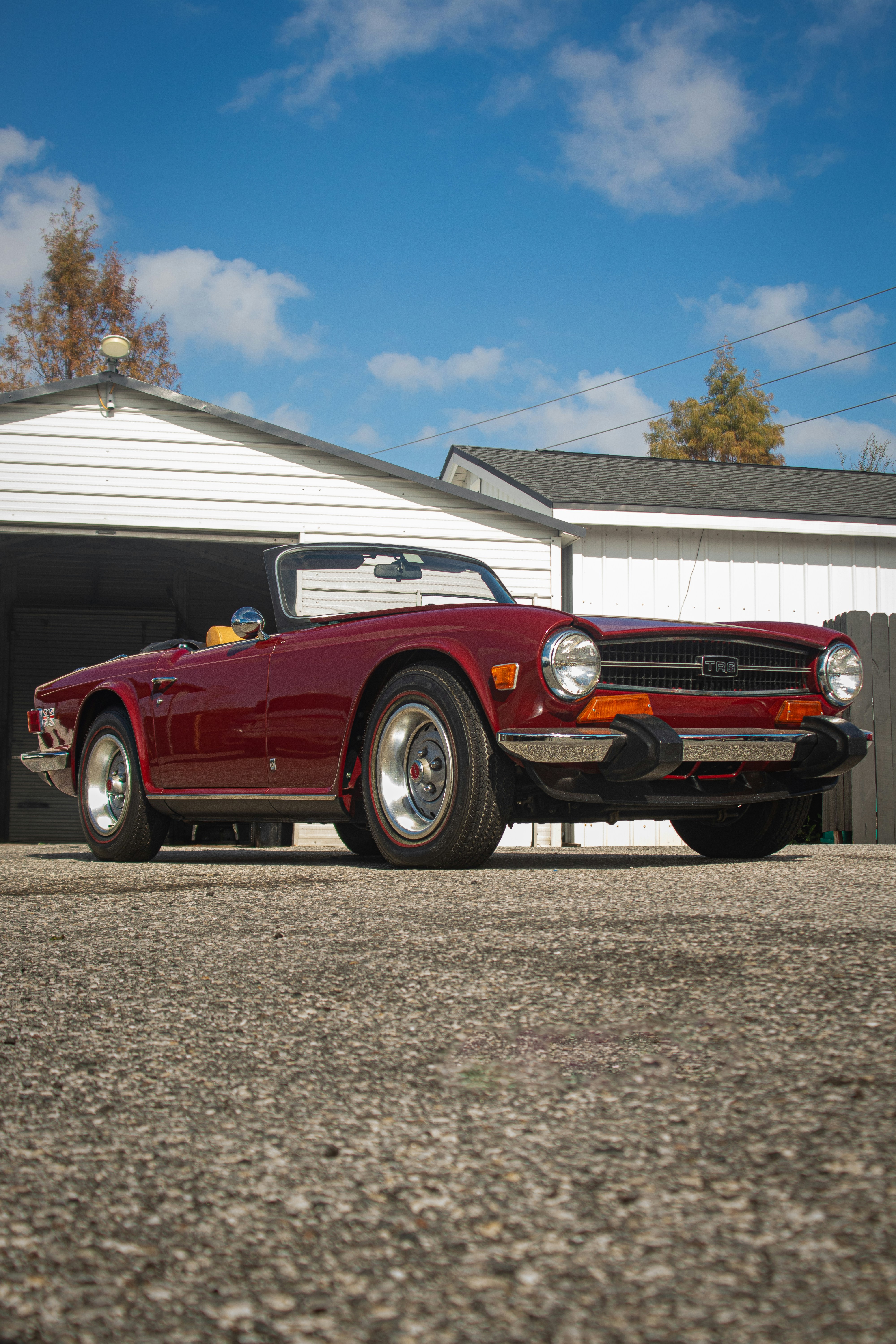 Crimson Classic: A Red Triumph Resting in the Driveway