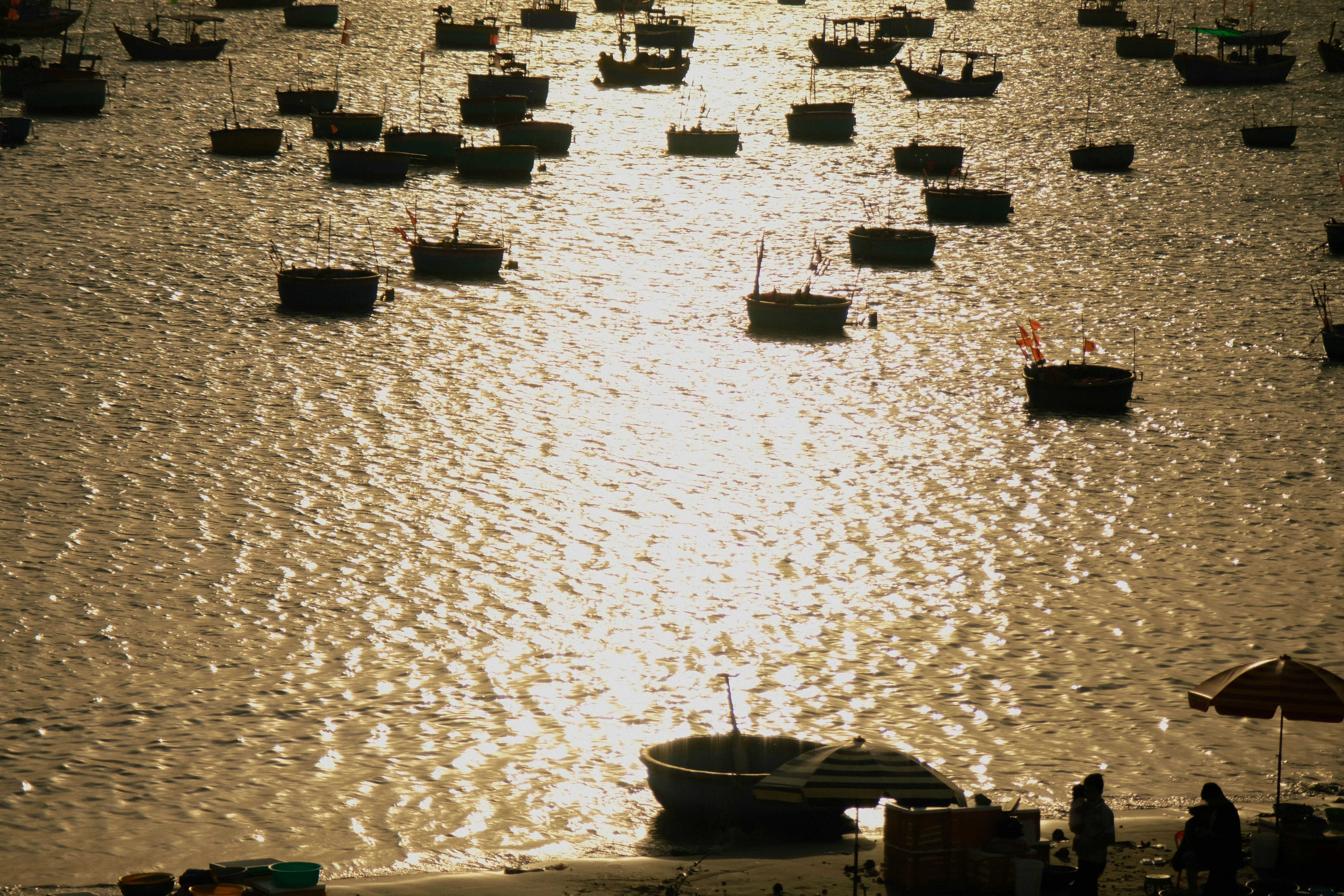 Golden Figures: Boats Dot the Quiet Sunset Harbor