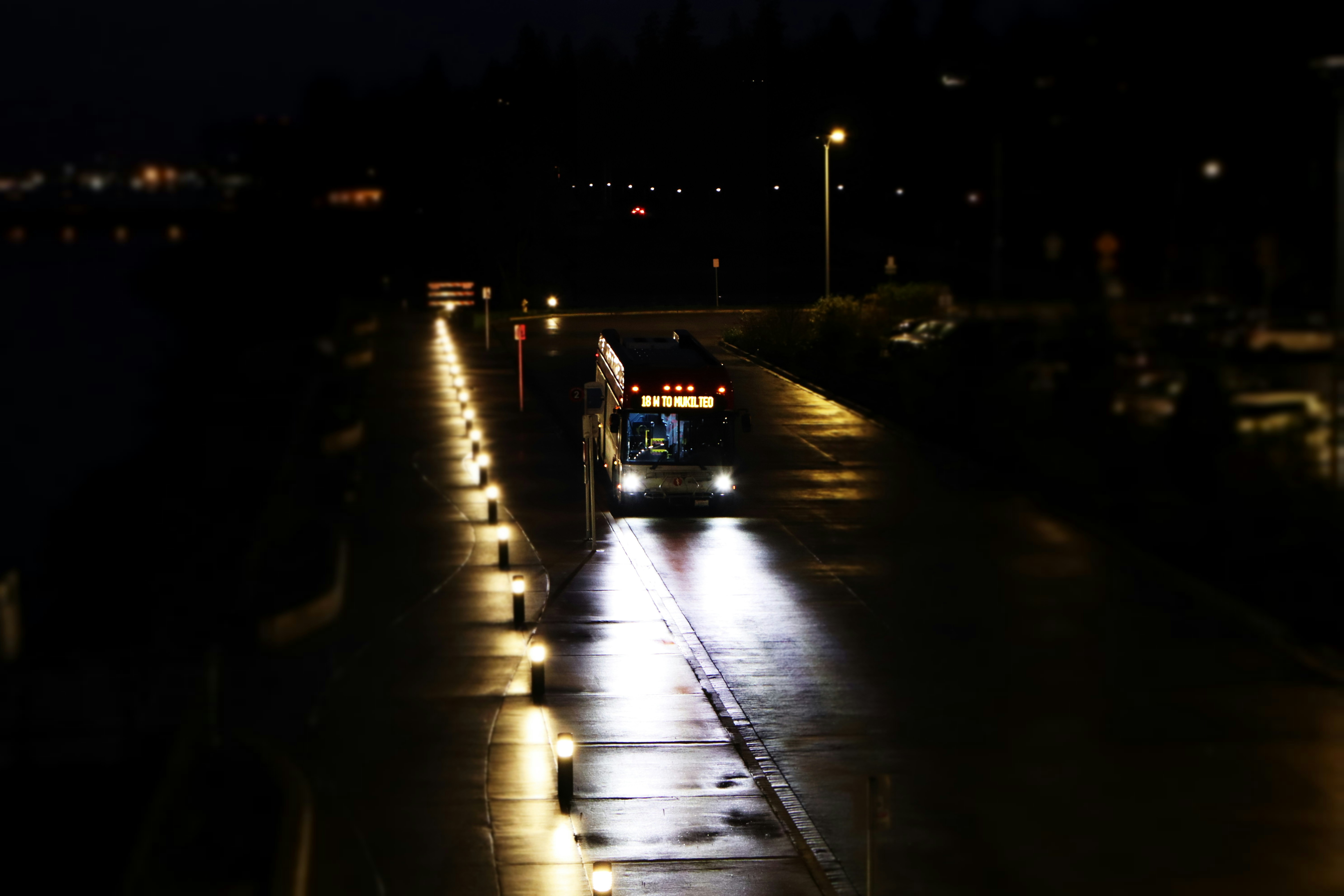 Nighttime Bus on a Wet Quiet Road