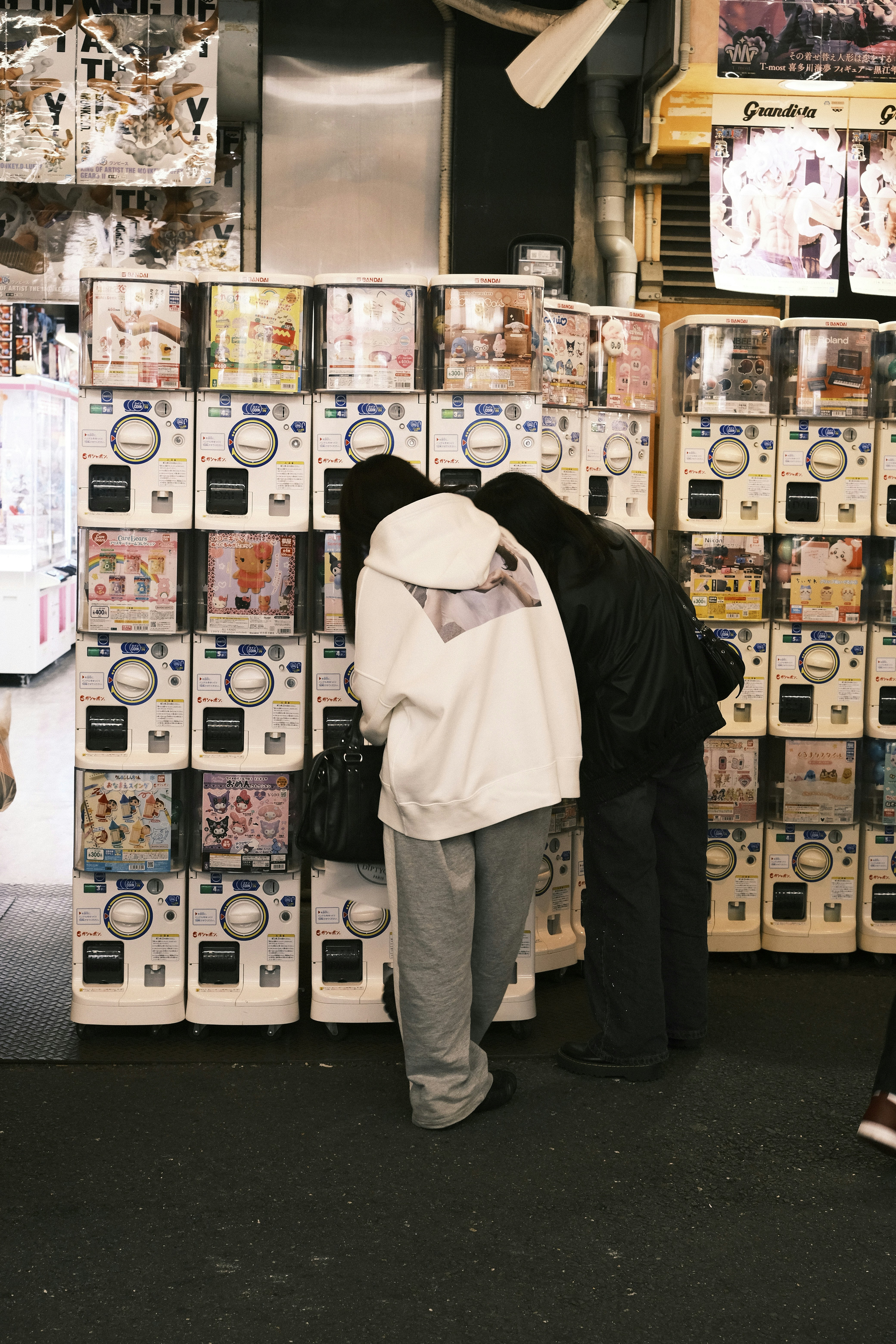 Gacha Wall Portraits: Two Shrouded Figures Lost in a Serial Carousel