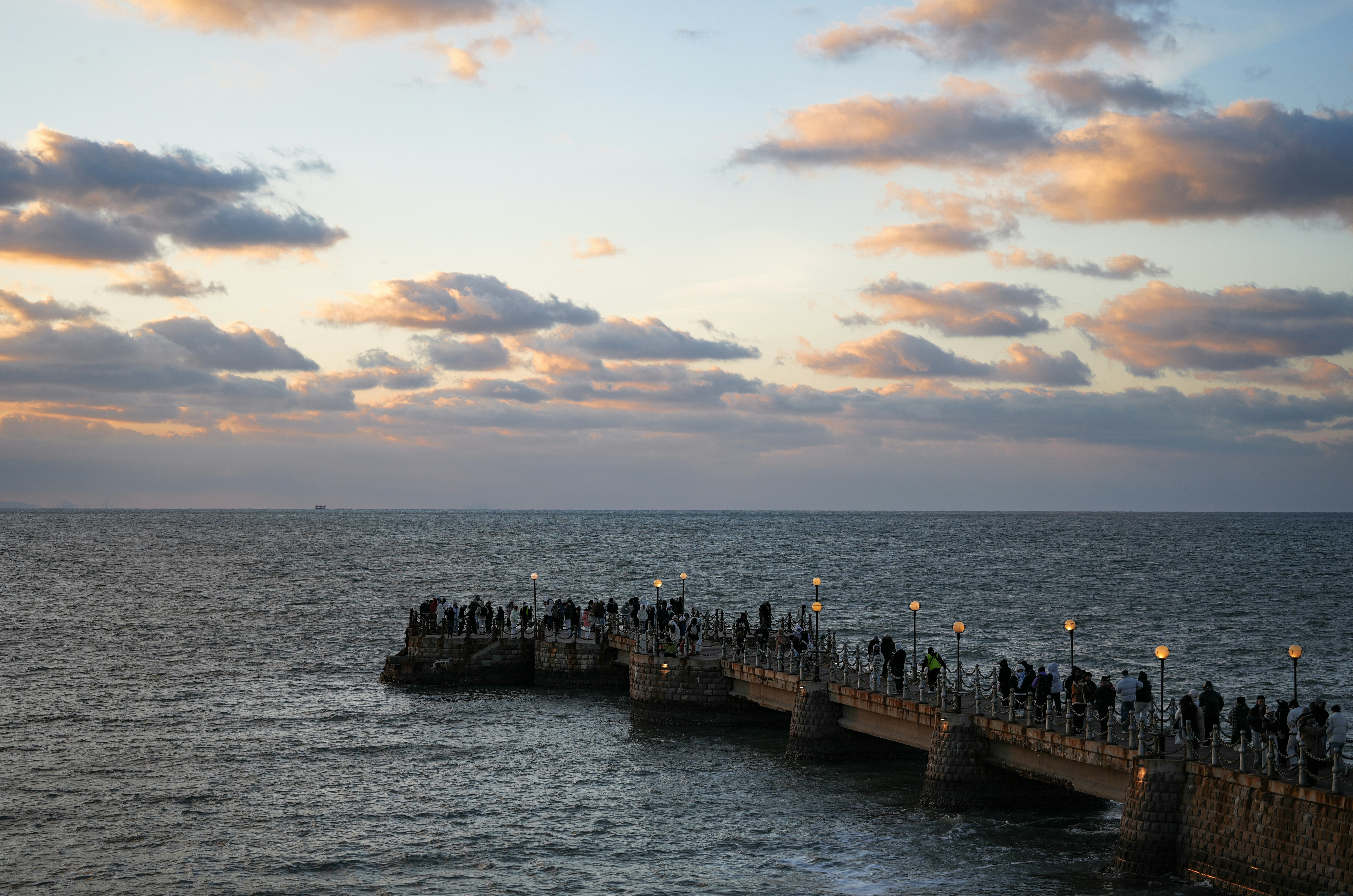 Sunset Pier: A Crowd at the Edge of the Sea