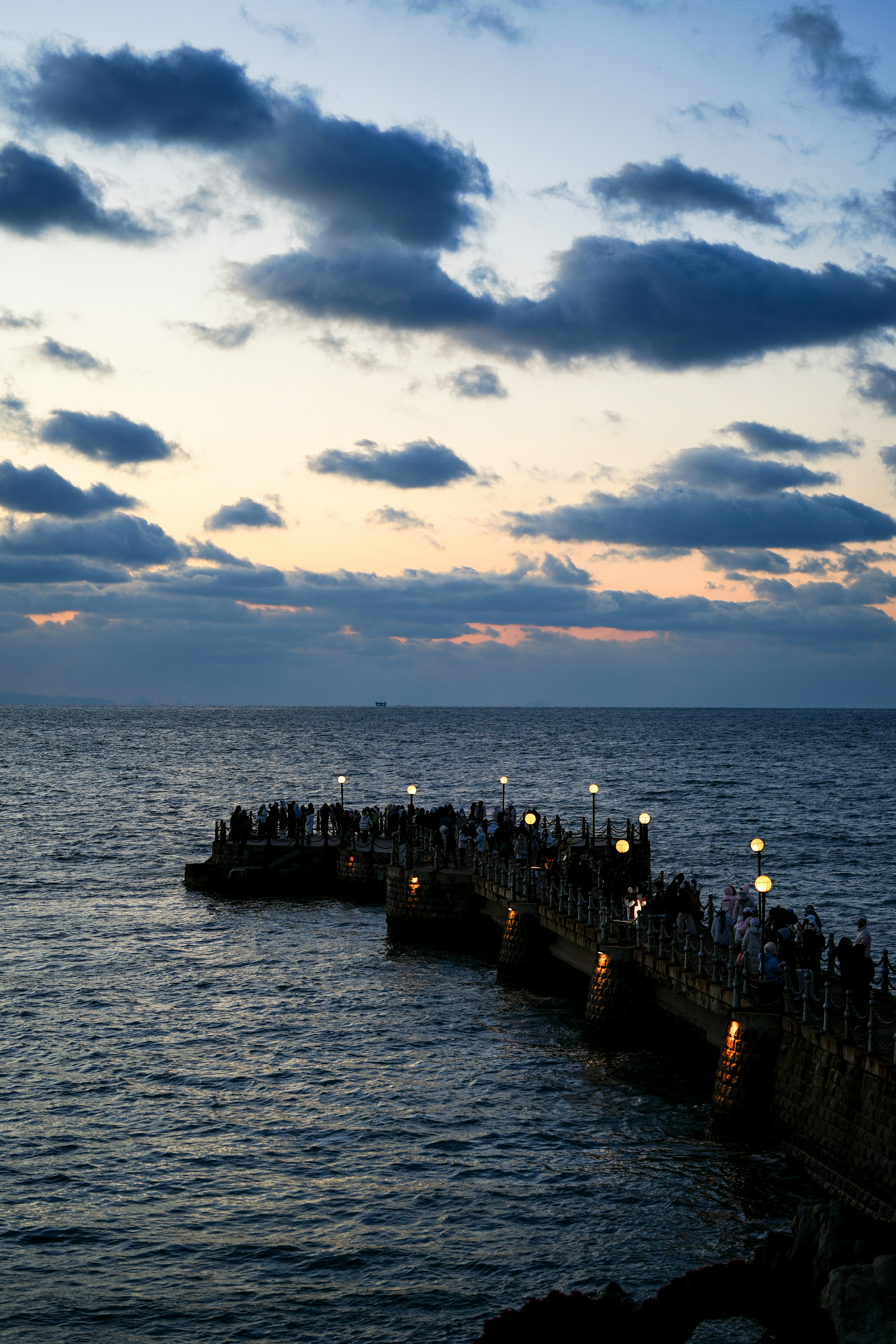 Evening Promenade: A Crowded Pier Reaches into the Calm Atlantic